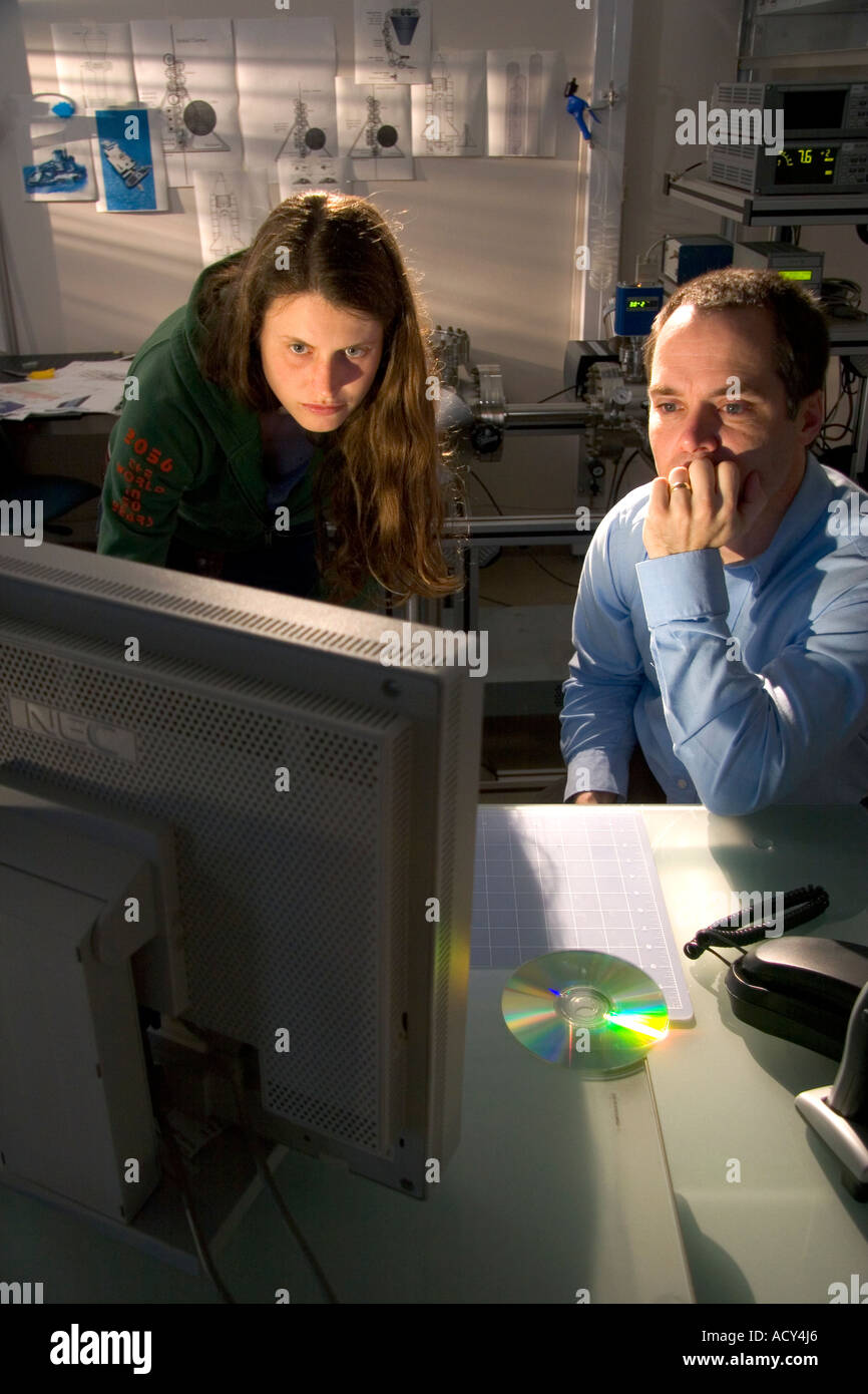 Scientist and researcher looking at computer screen data in a lab Stock ...