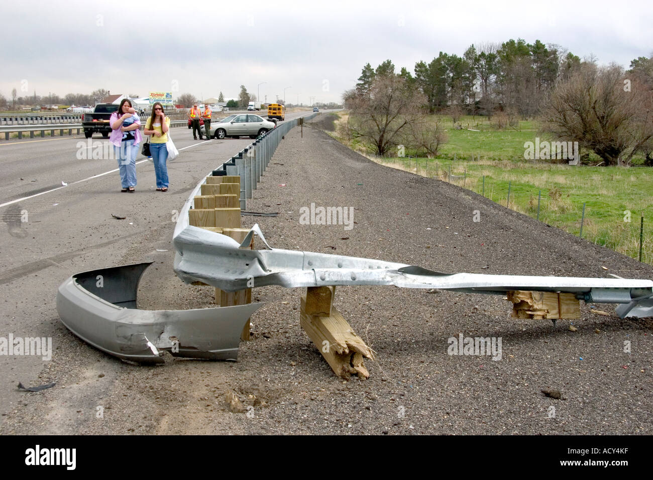 Automoblie accident scene with skid marks and broken guard rail on ...