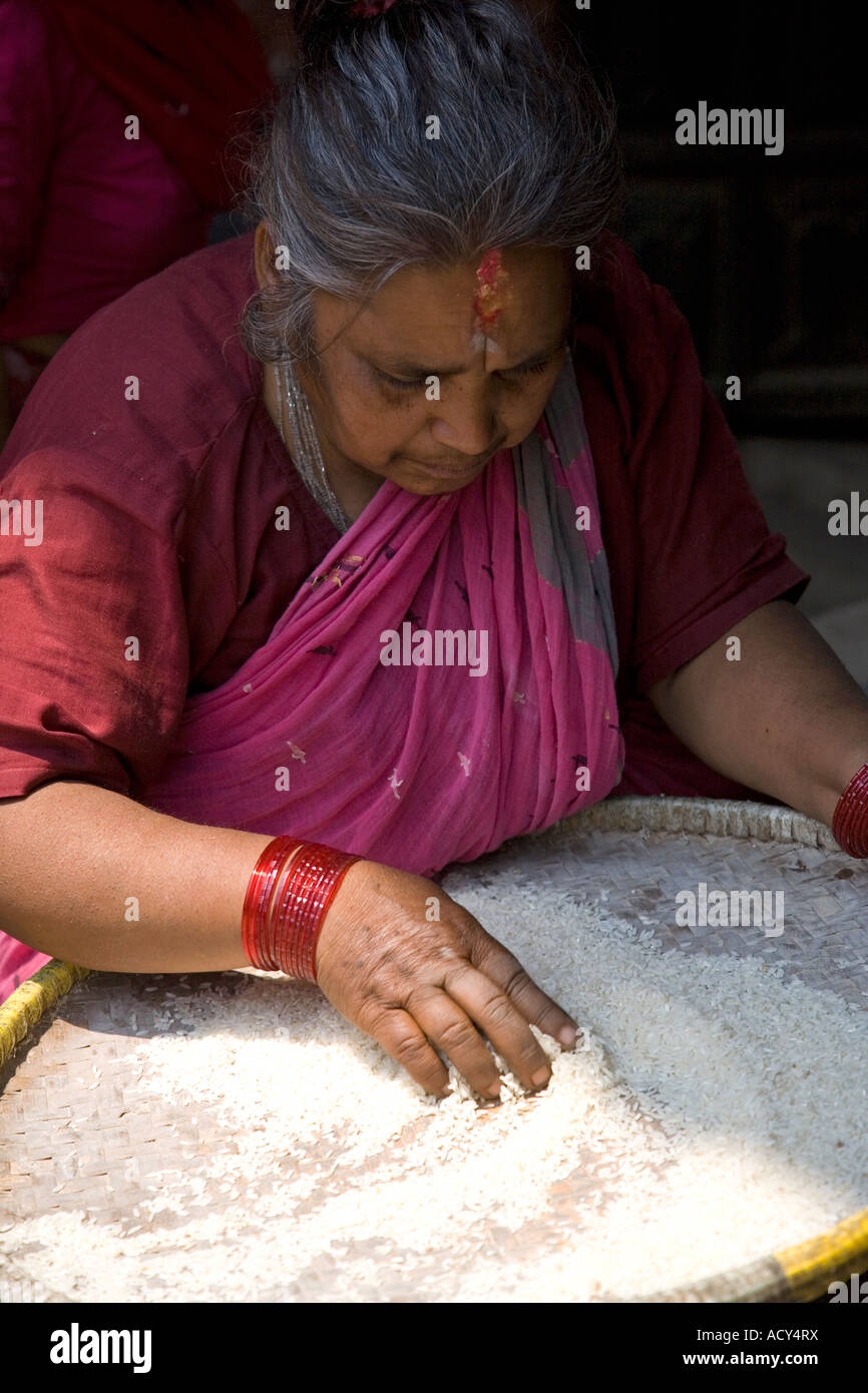 Nepali woman cleaning rice.Indra Chowk marketplace.Kathmandu.Nepal ...