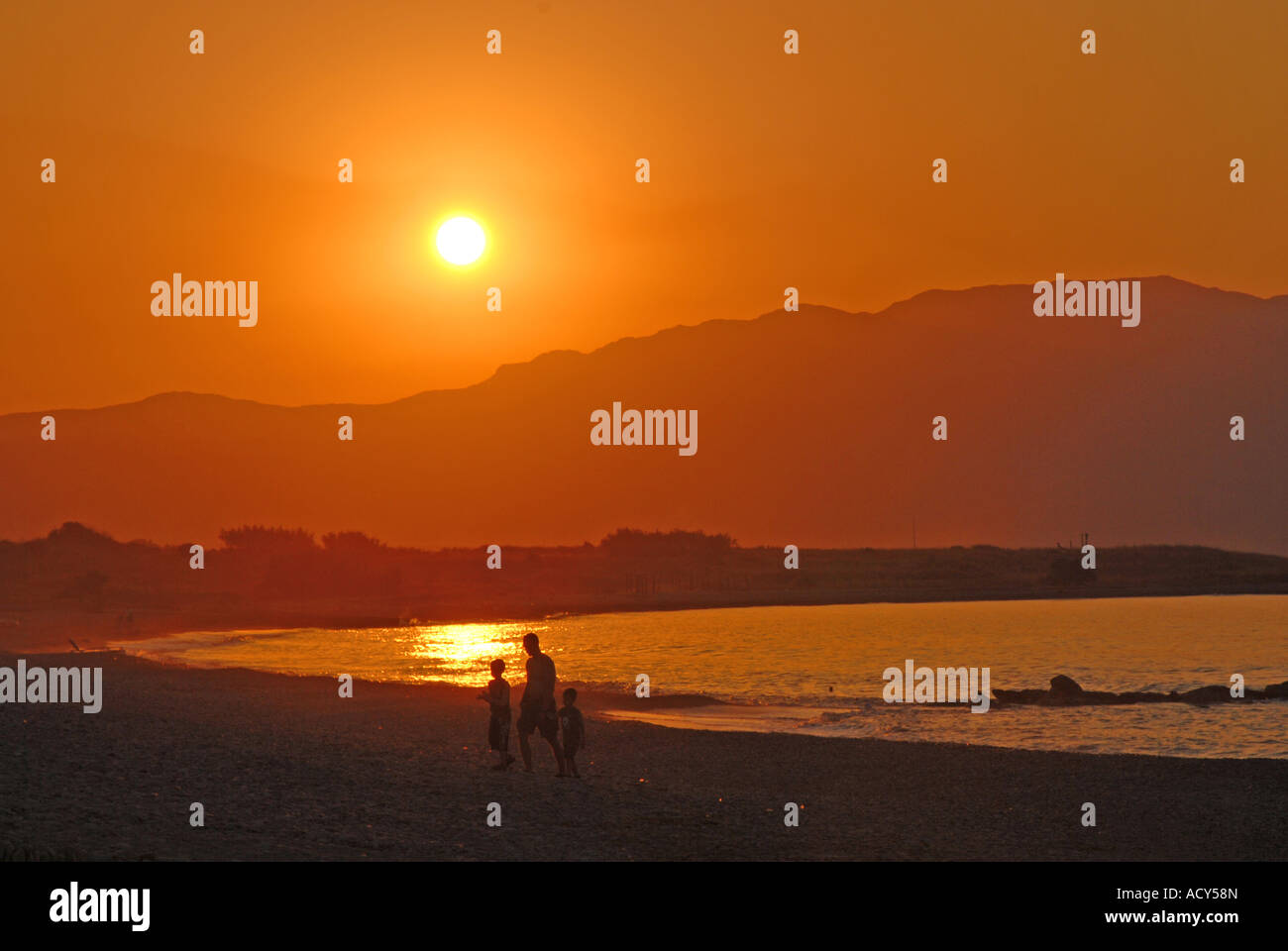 CRETE Sunset over the Rodhopou Peninsula seen from the beach at Maleme ...