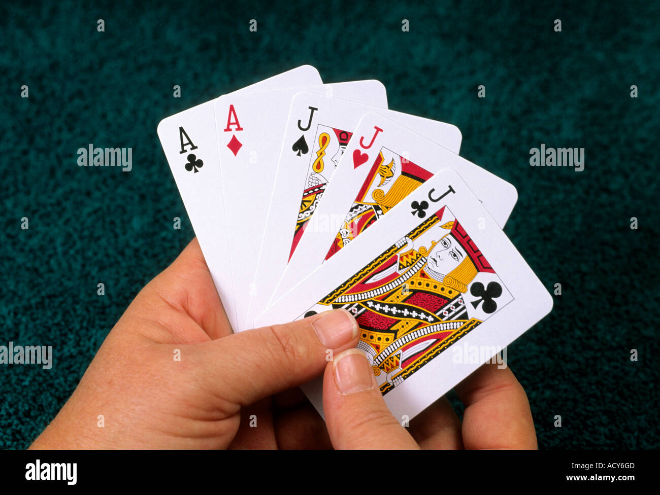 A poker hand of playing cards showing a full house Stock Photo - Alamy
