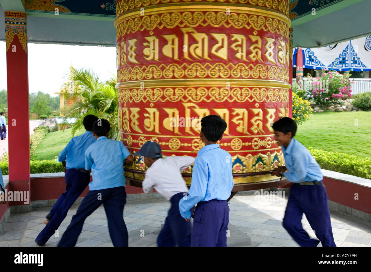 Children spinning a big prayer wheel. German Buddhist monastery ...