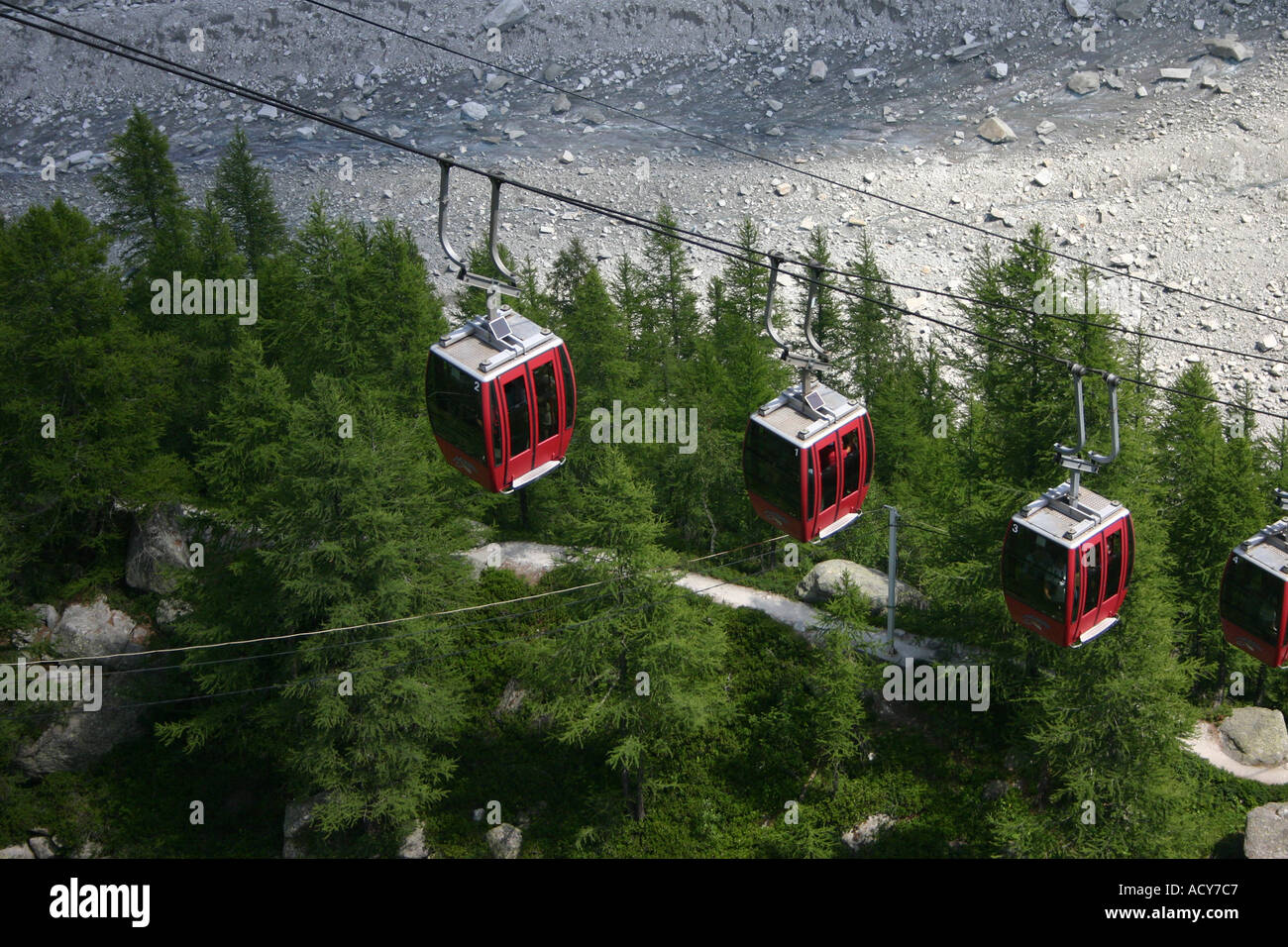 Gondolas cable car serving the ice cave in the Mer de Glace Glacier at ...