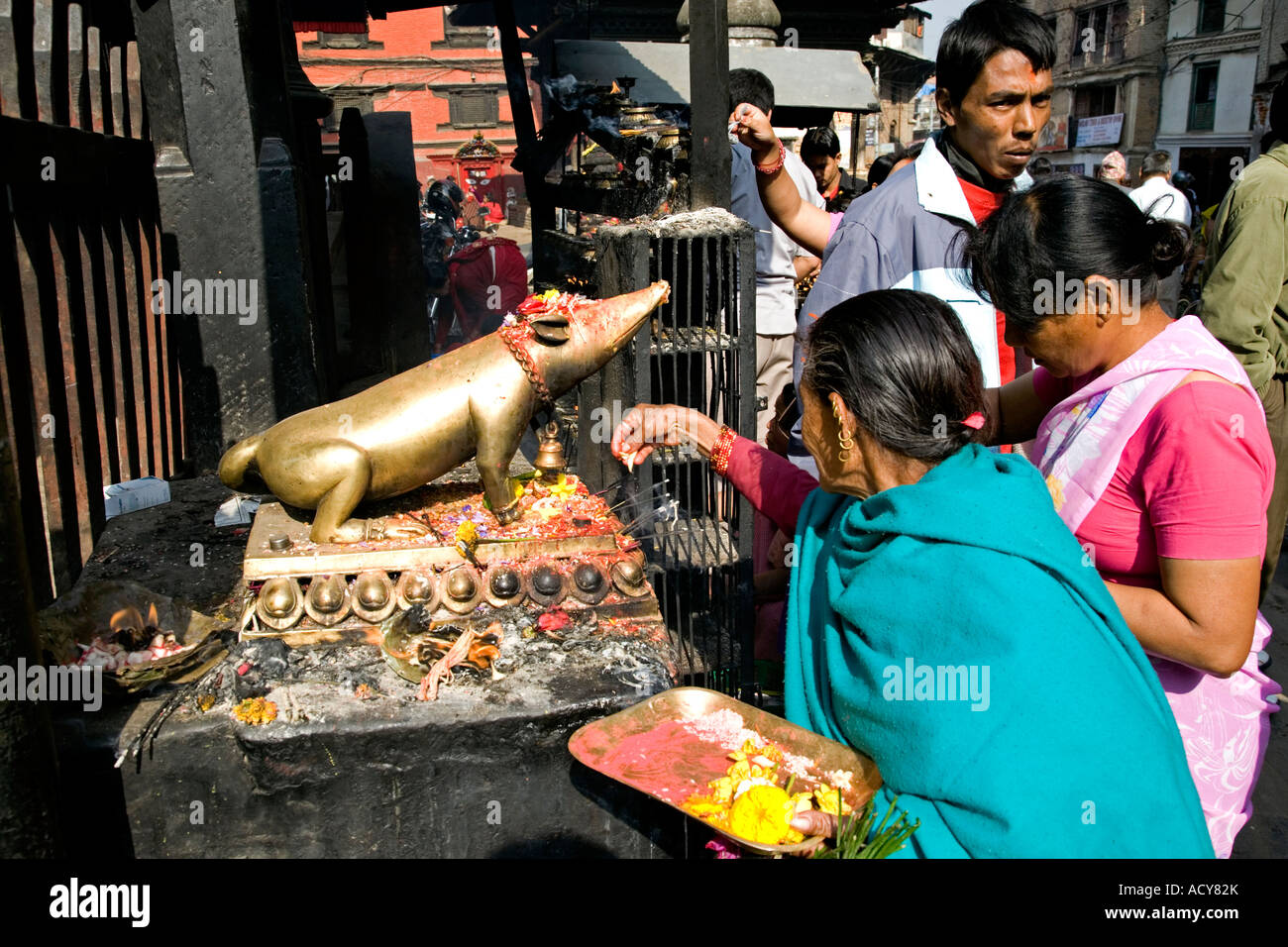 Nepali women making an offering to the Rat.It is the mount of Ganesh ...