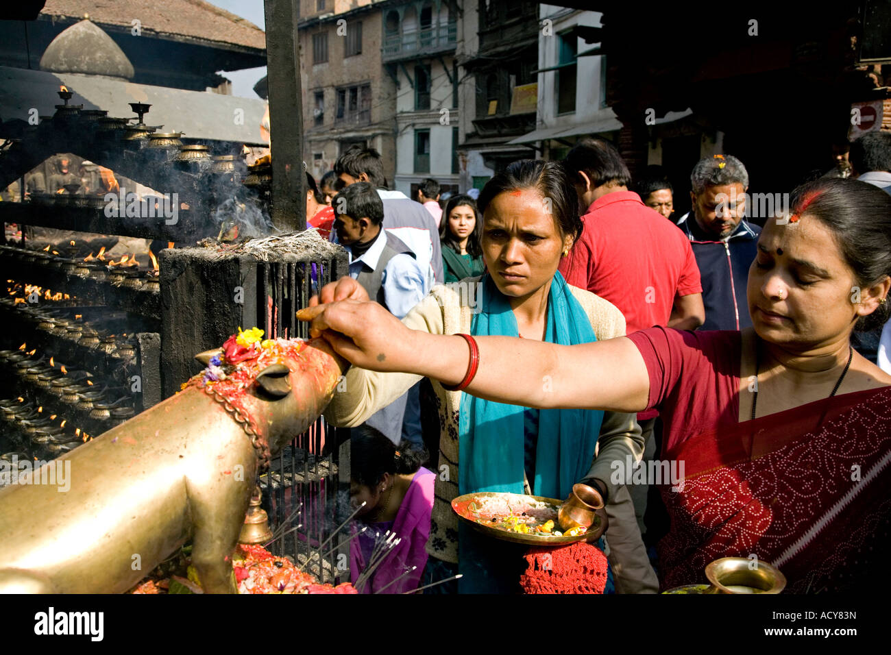 Nepali woman makin an offering to the Rat.It is the mount of Ganesh ...