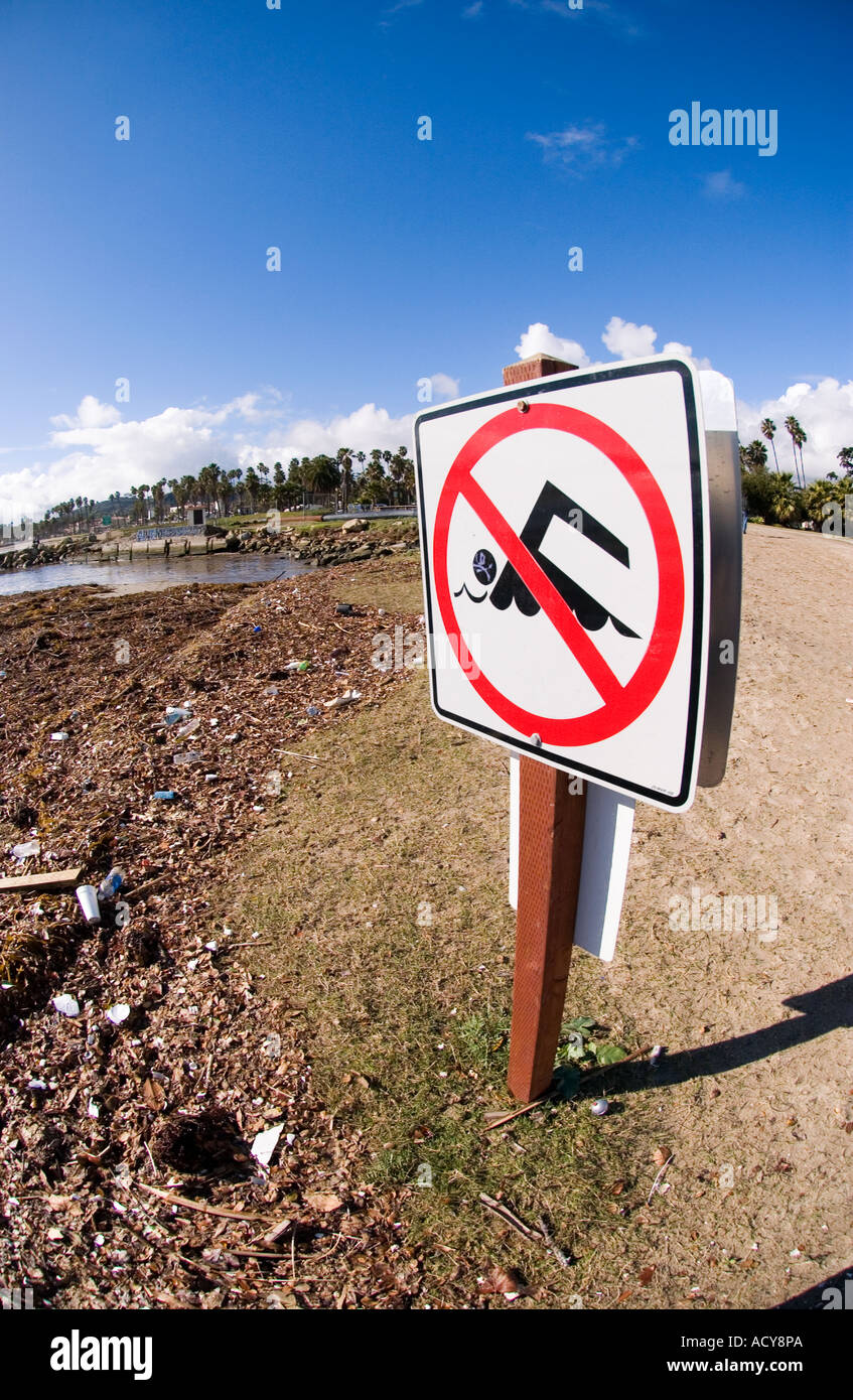 No swimming warning sign an dirty beach due to high amount of ocean ...