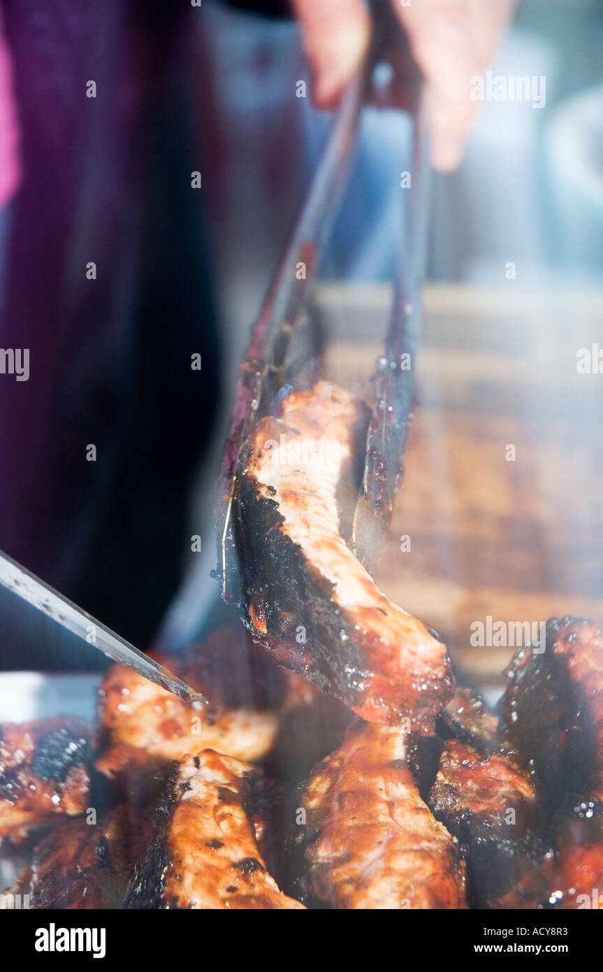 hands cooking Barbecue spare ribs at over grill Stock Photo - Alamy