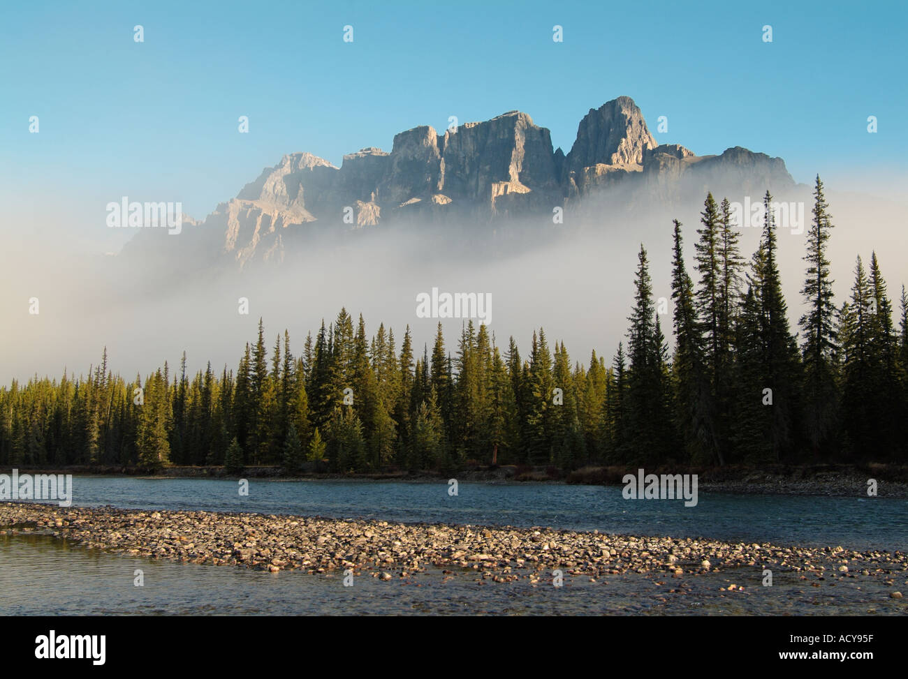 Mist rising from Bow river Castle Mountain early morning at castle Junction Bow Valley Parkway ...