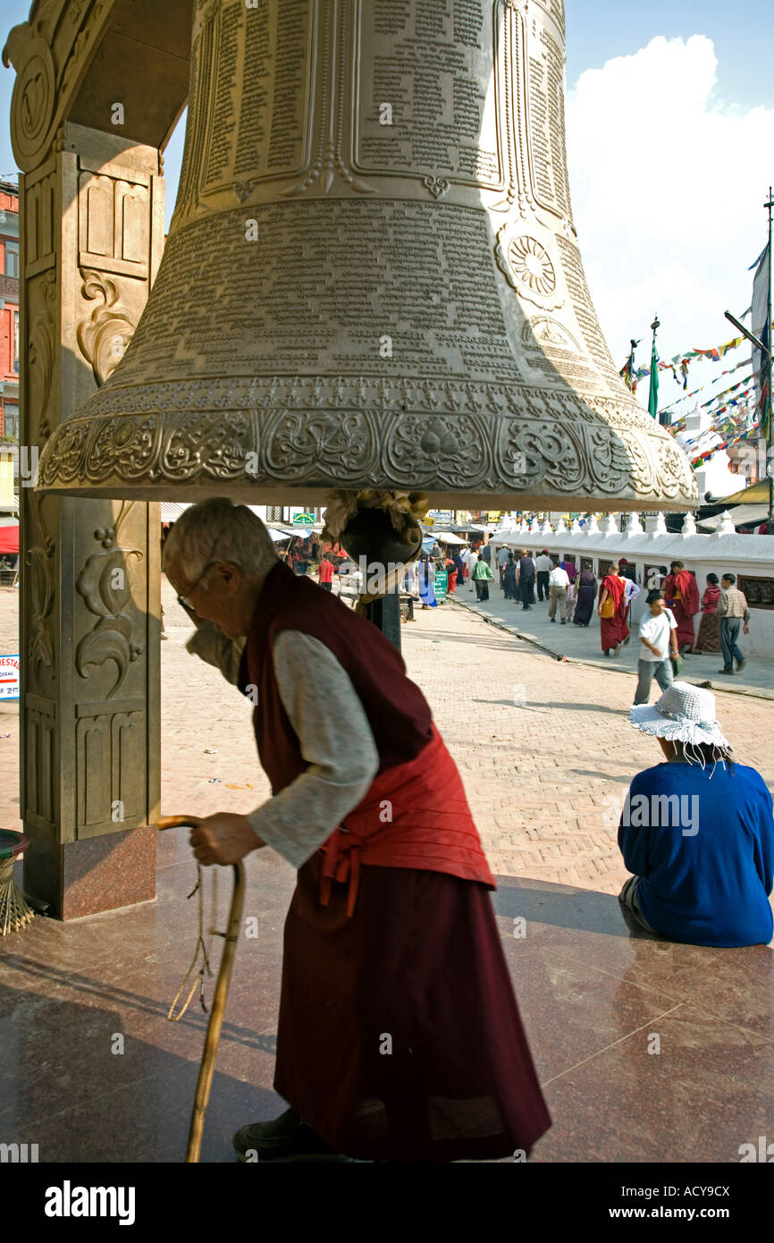 Tibetan nun praying under Ajima Holy Bell. Bodhnath Stupa. Kathmandu ...