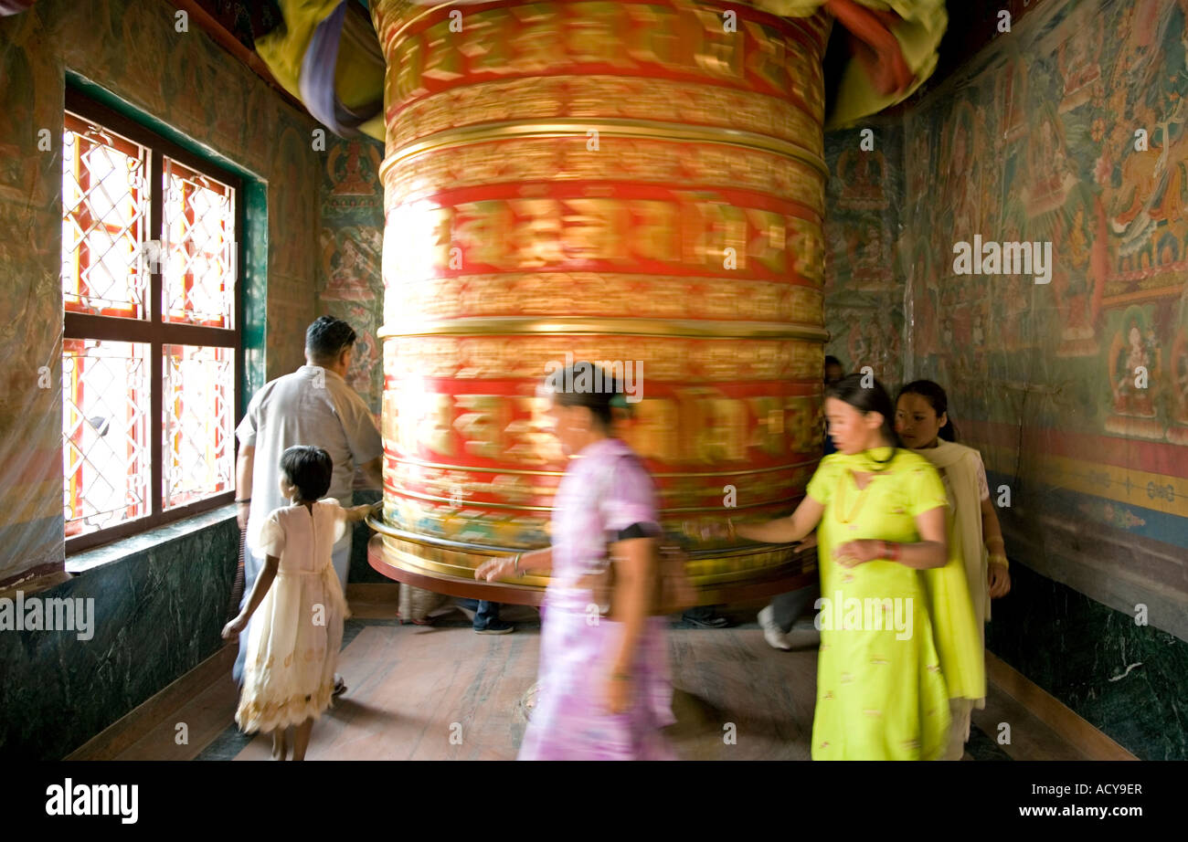 Pilgrims spinning a big prayer wheel.Tsamchen Gompa.Bodhnath Stupa ...