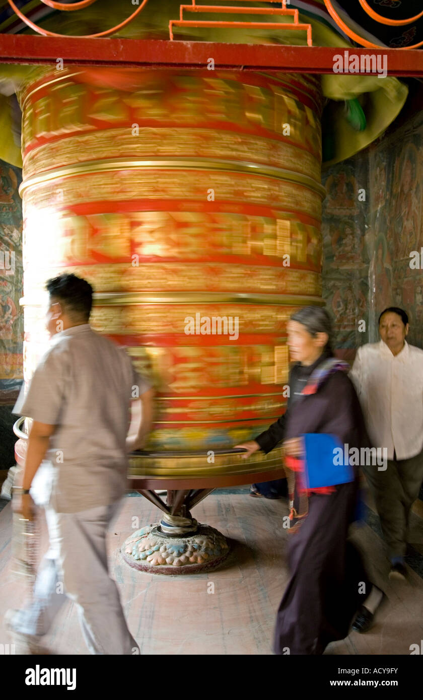 Pilgrims spinning a big prayer wheel.Tsamchen Gompa.Bodhnath Stupa ...