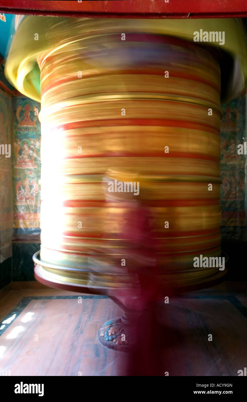 Buddhit monk spinning a big prayer wheel.Tsamchen Gompa.Bodhnath Stupa ...