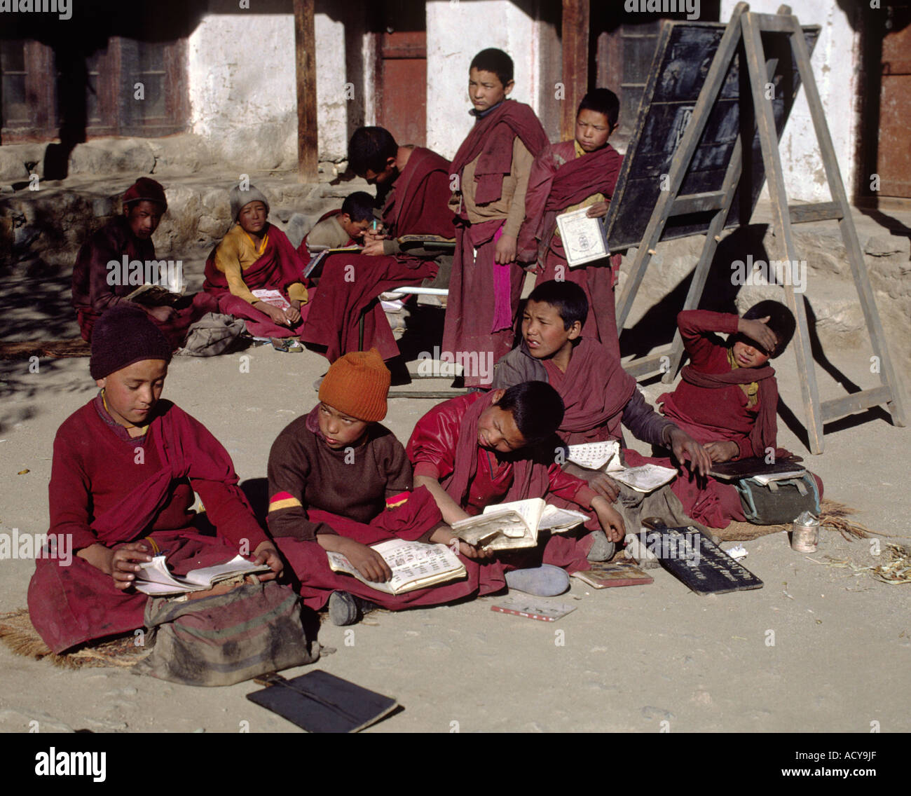 Young BUDDHIST MONKS study during class in the monastic SCHOOL at LEKIR ...