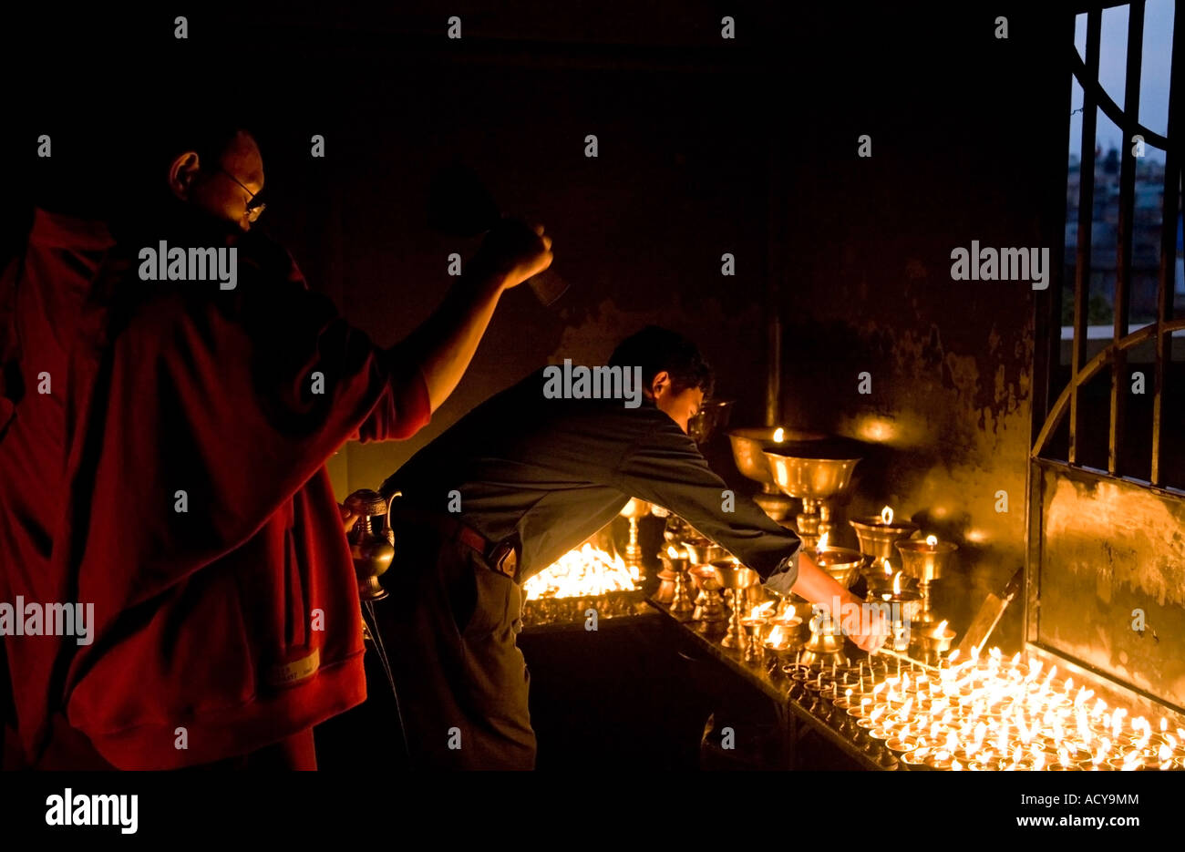 Pilgrims lighting butter lamps.Tsamchen Gompa.Bodhnath Gompa.Nepal ...