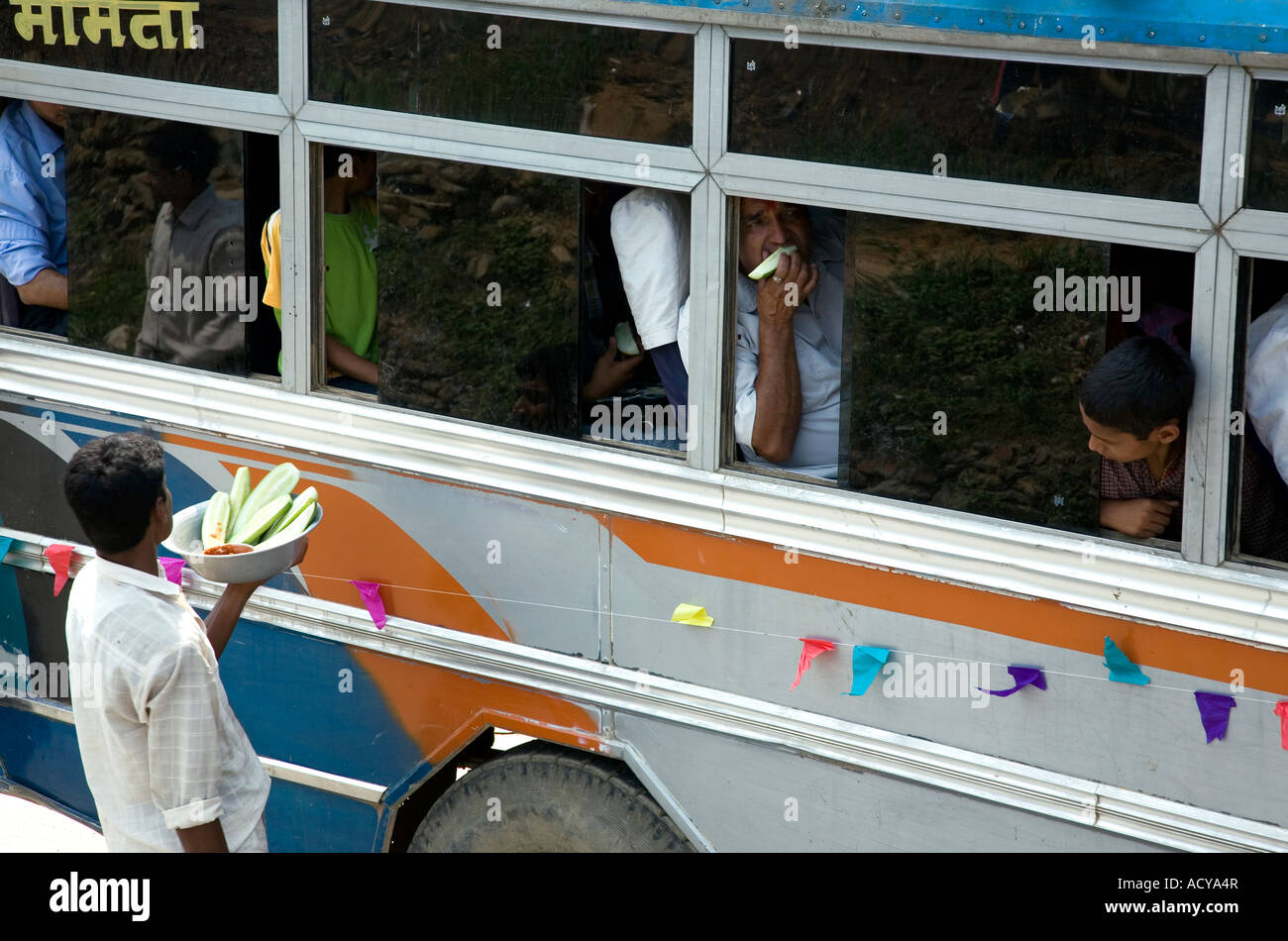 Man selling cucumbers. Bus stop. Butwal. Nepal Stock Photo - Alamy