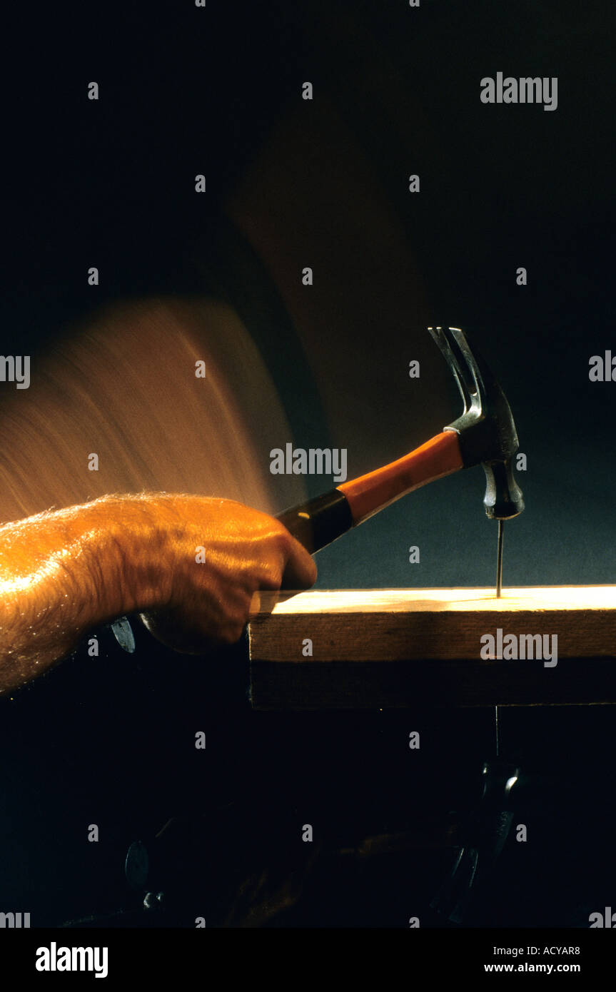 A hammer hitting a nail Stock Photo - Alamy
