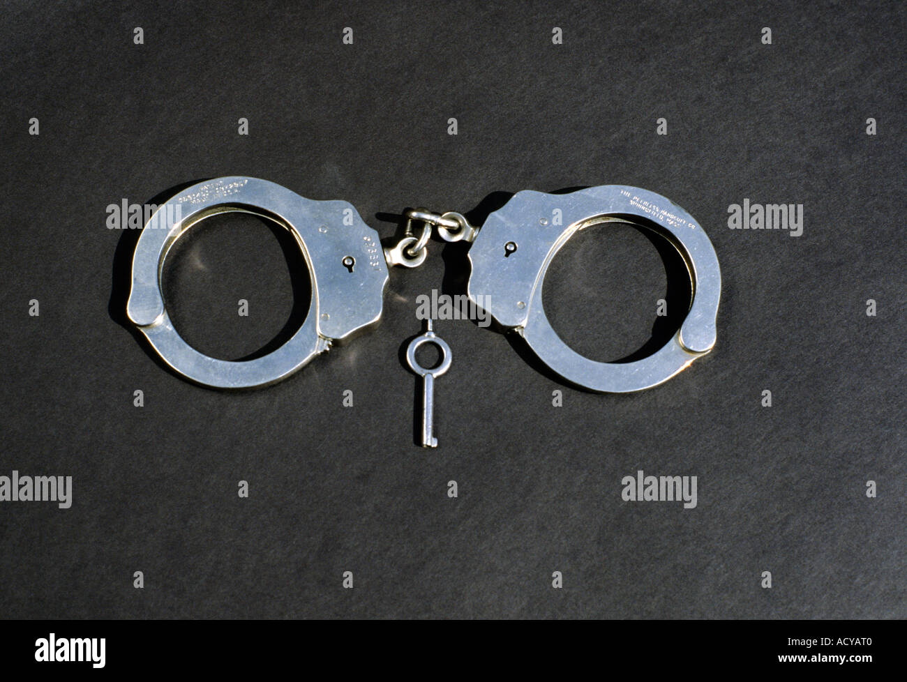 Handcuffs and key Stock Photo - Alamy