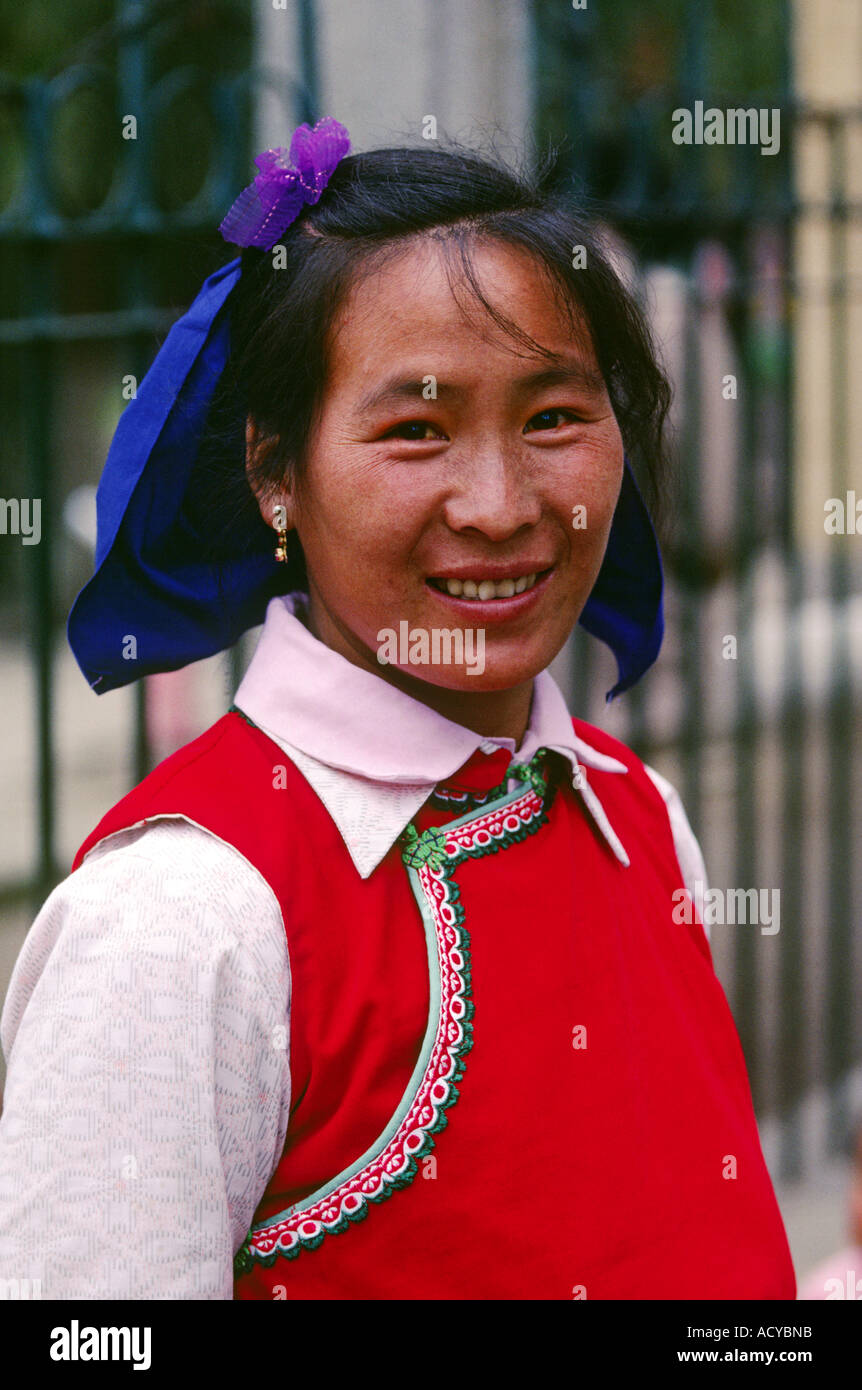 Chinese WOMEN dressed in TRADITIONAL GARB walk through the streets of ...