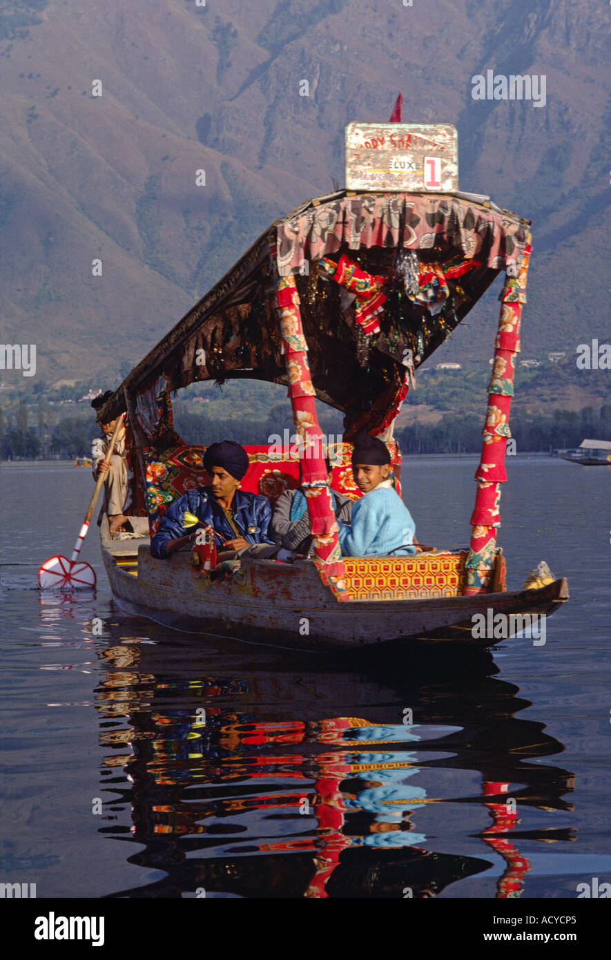 INDIAN TOURISTS take a ride in a SHIKARA local paddle boat with a ...