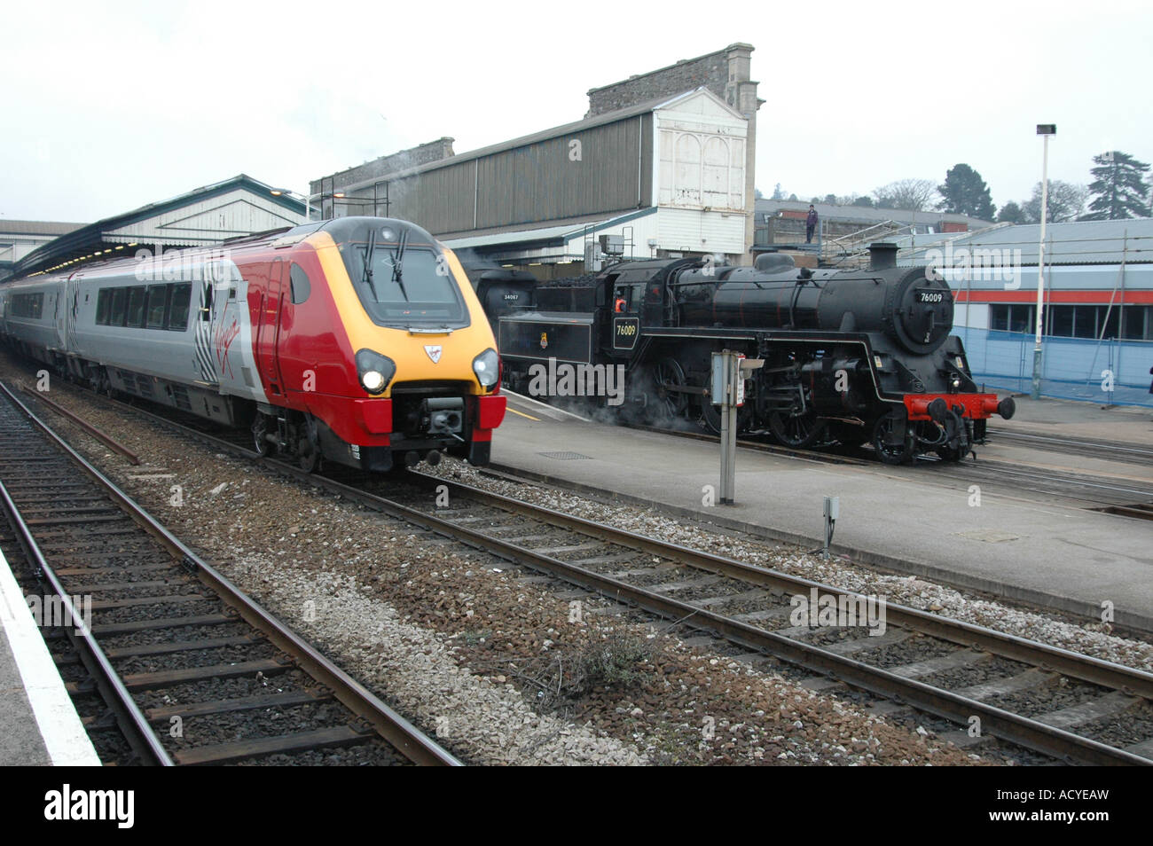 Modern Virgin Voyager diesel train alongside 1950s steam engine at ...