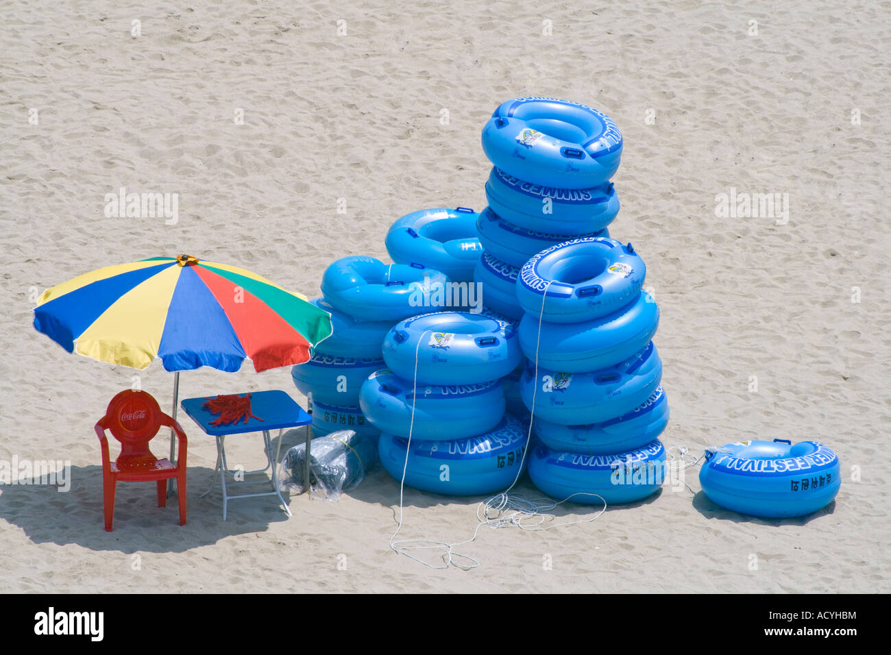 Floating Tires And Parasol at the Beach Stock Photo - Alamy