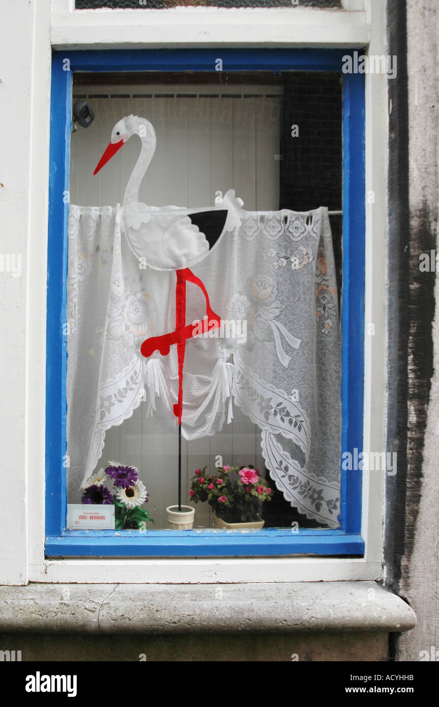 Window display of stork standing in a flower pot depicting birth of ...