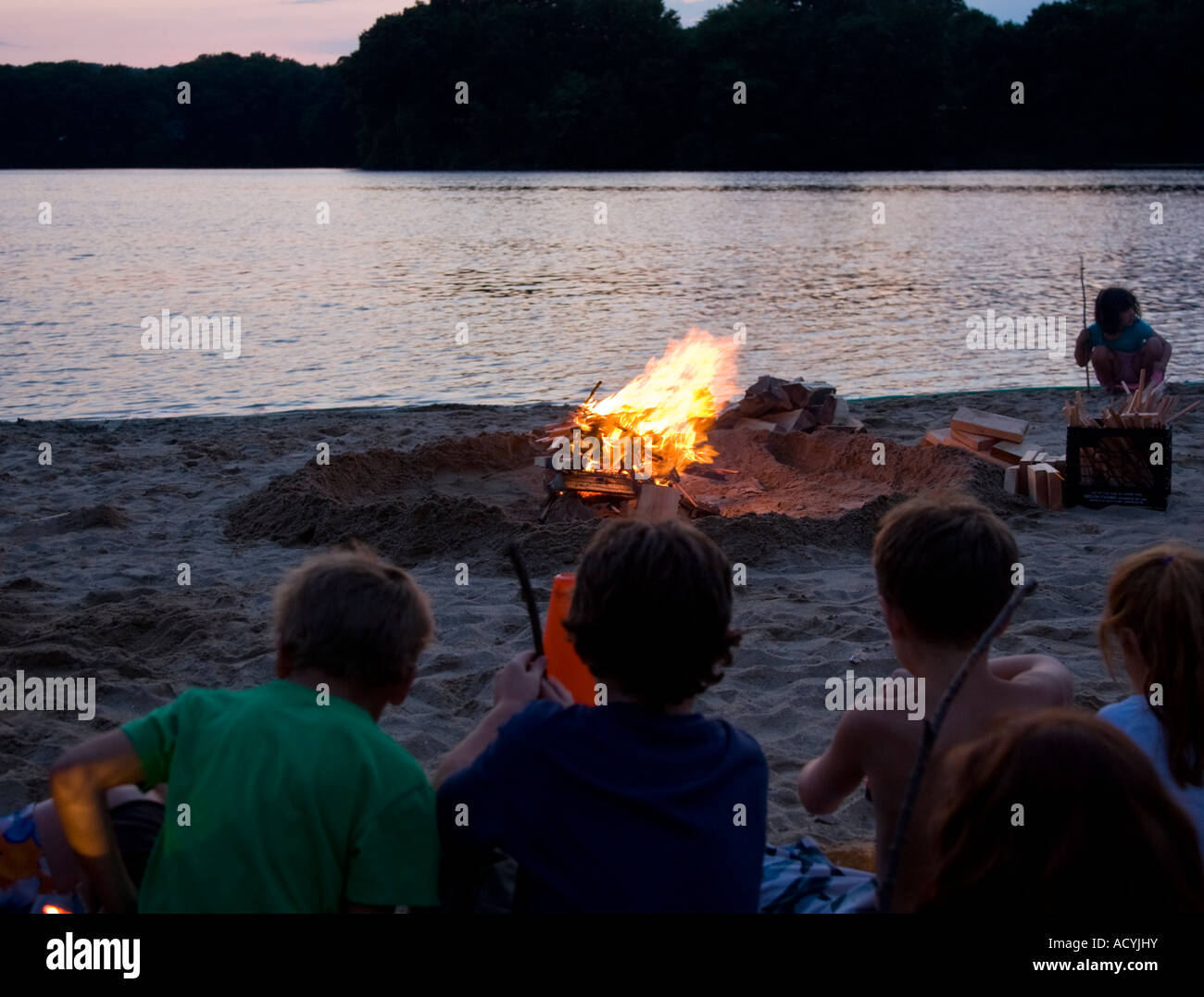 Children sitting around a campfire Stock Photo - Alamy