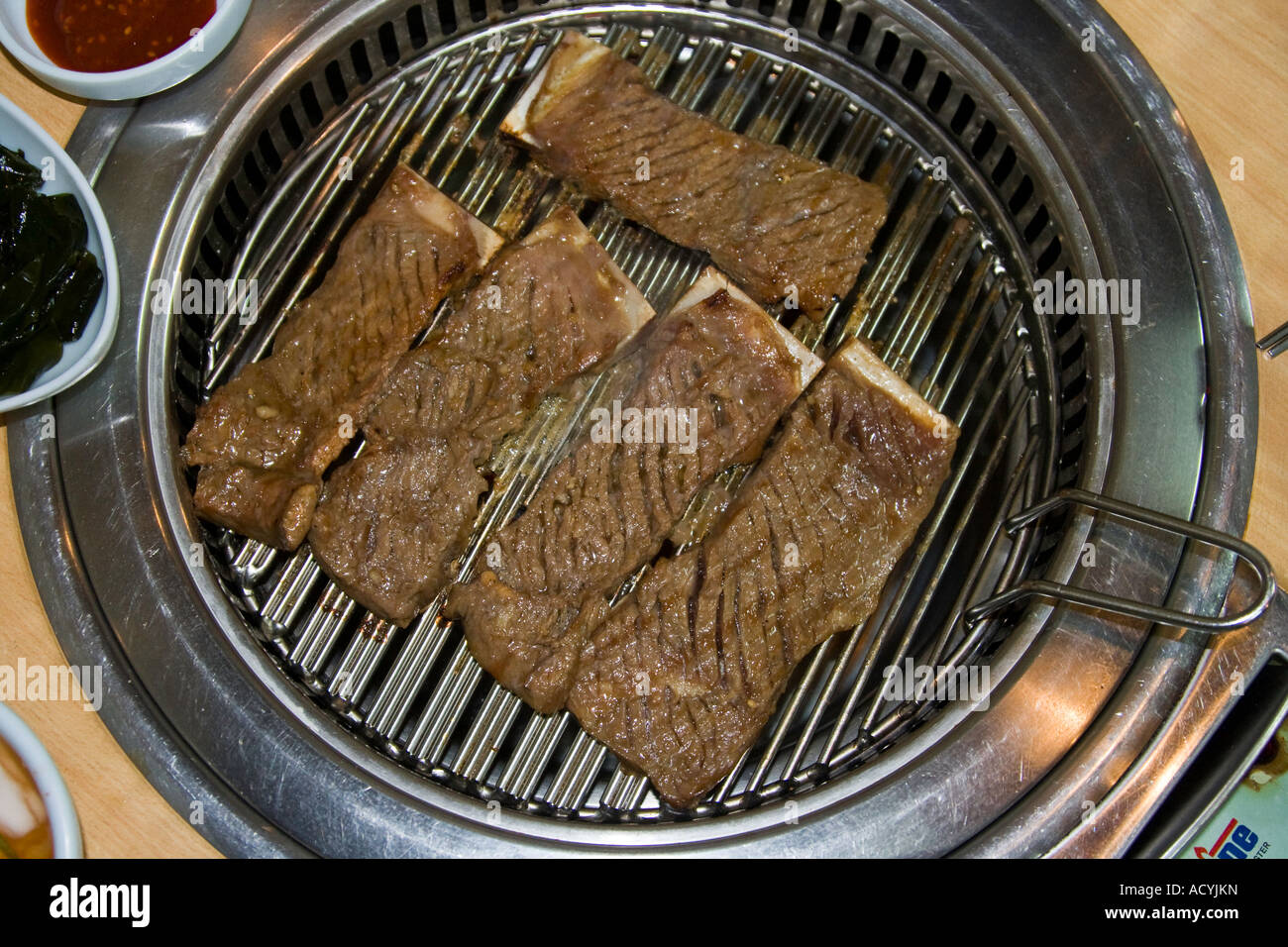 Kalbi or Galbi Beef Ribs Grilling on the BBQ at a Korean Galbi House ...