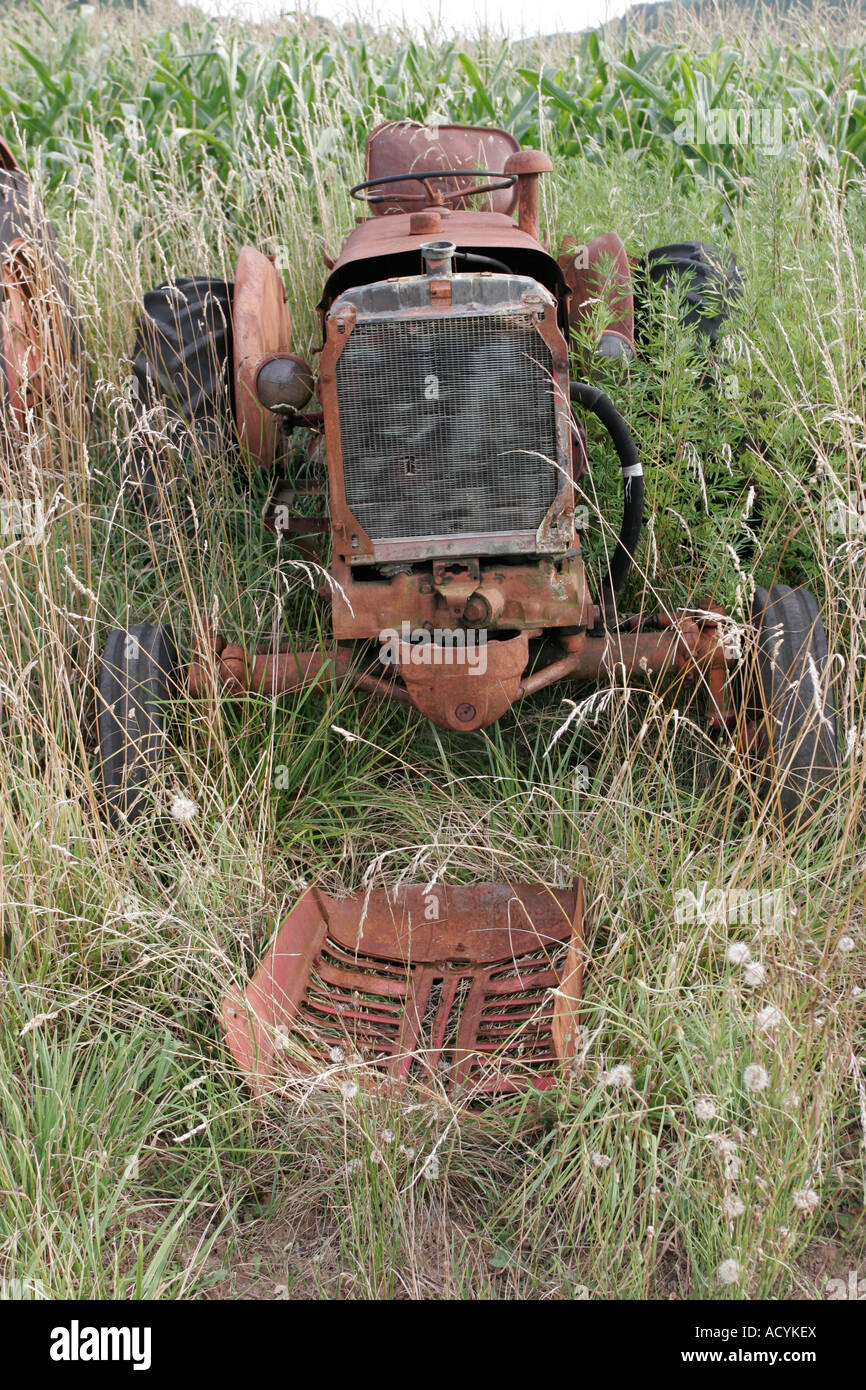 Front head on view of an old broken farm tractor rusting away in a ...
