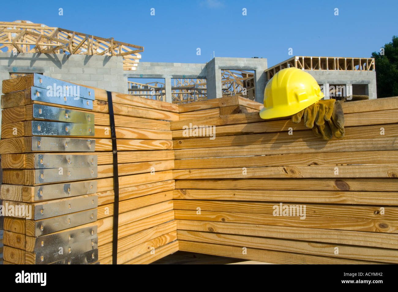 lumber stacked up at construction site for home building Stock Photo ...