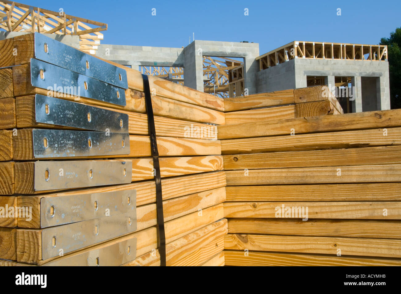 lumber stacked up at construction site for home building Stock Photo ...