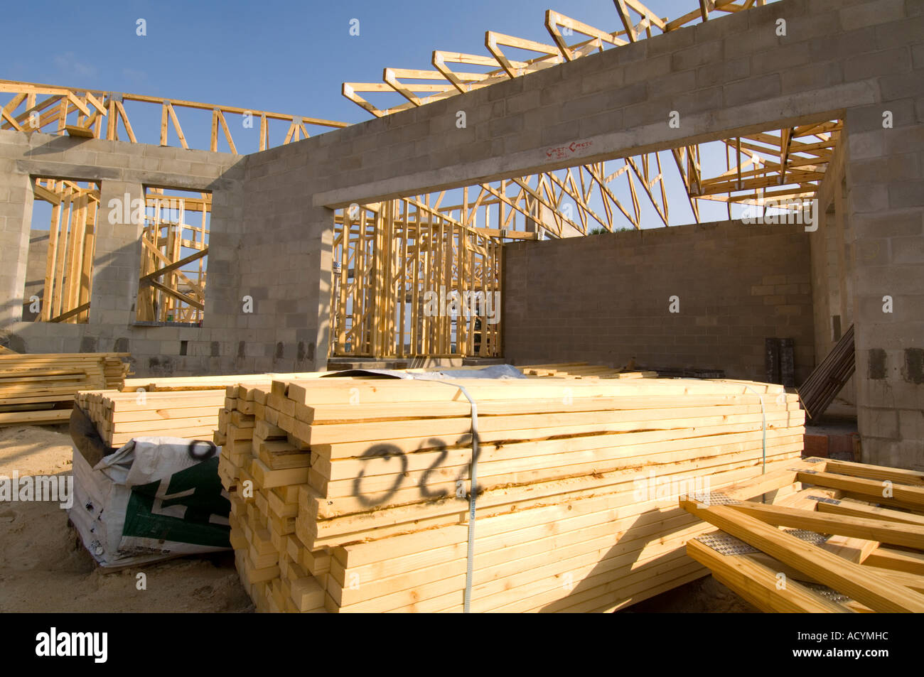 lumber stacked up at construction site for home building Stock Photo ...