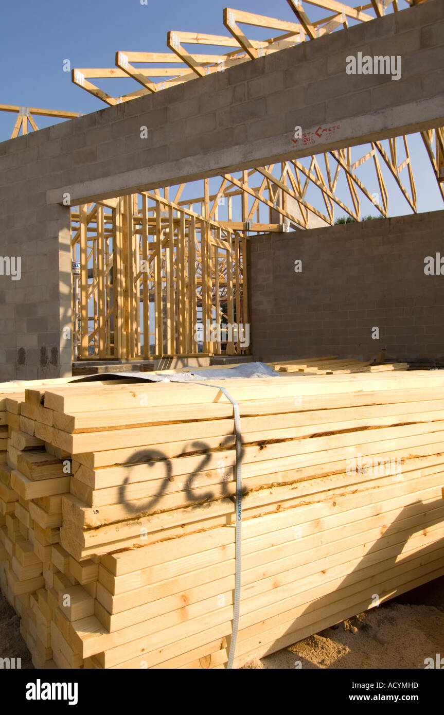 lumber stacked up at construction site for home building Stock Photo ...