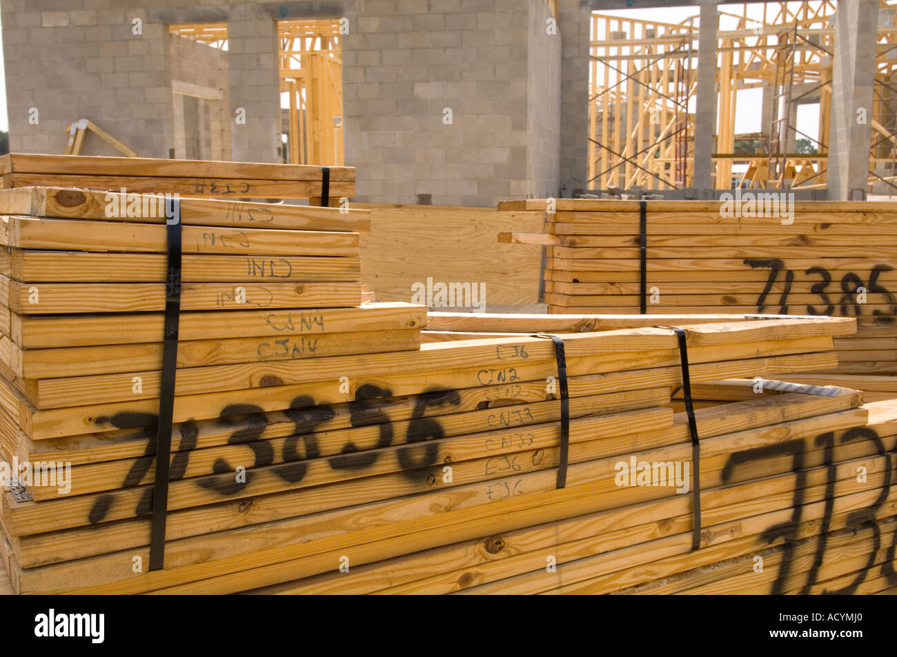 lumber stacked up at construction site for home building Stock Photo ...