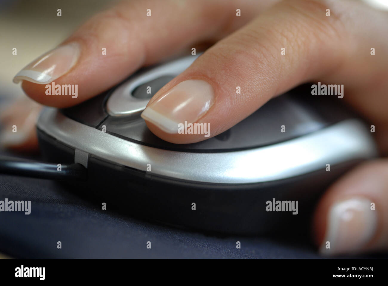 Womans hand using a computer mouse with scroll wheel in an office Stock ...