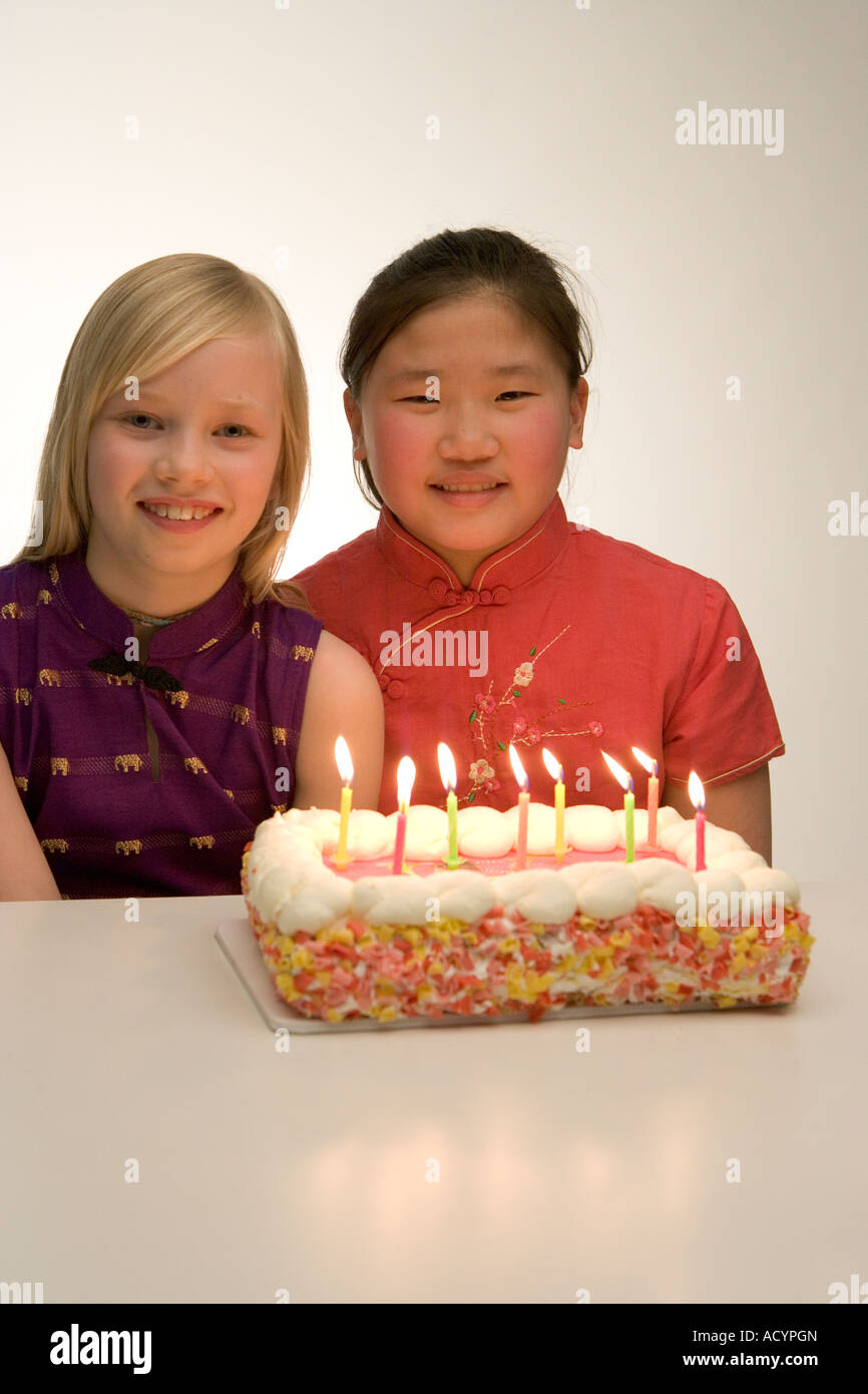Two girls with a birthday cake Stock Photo - Alamy