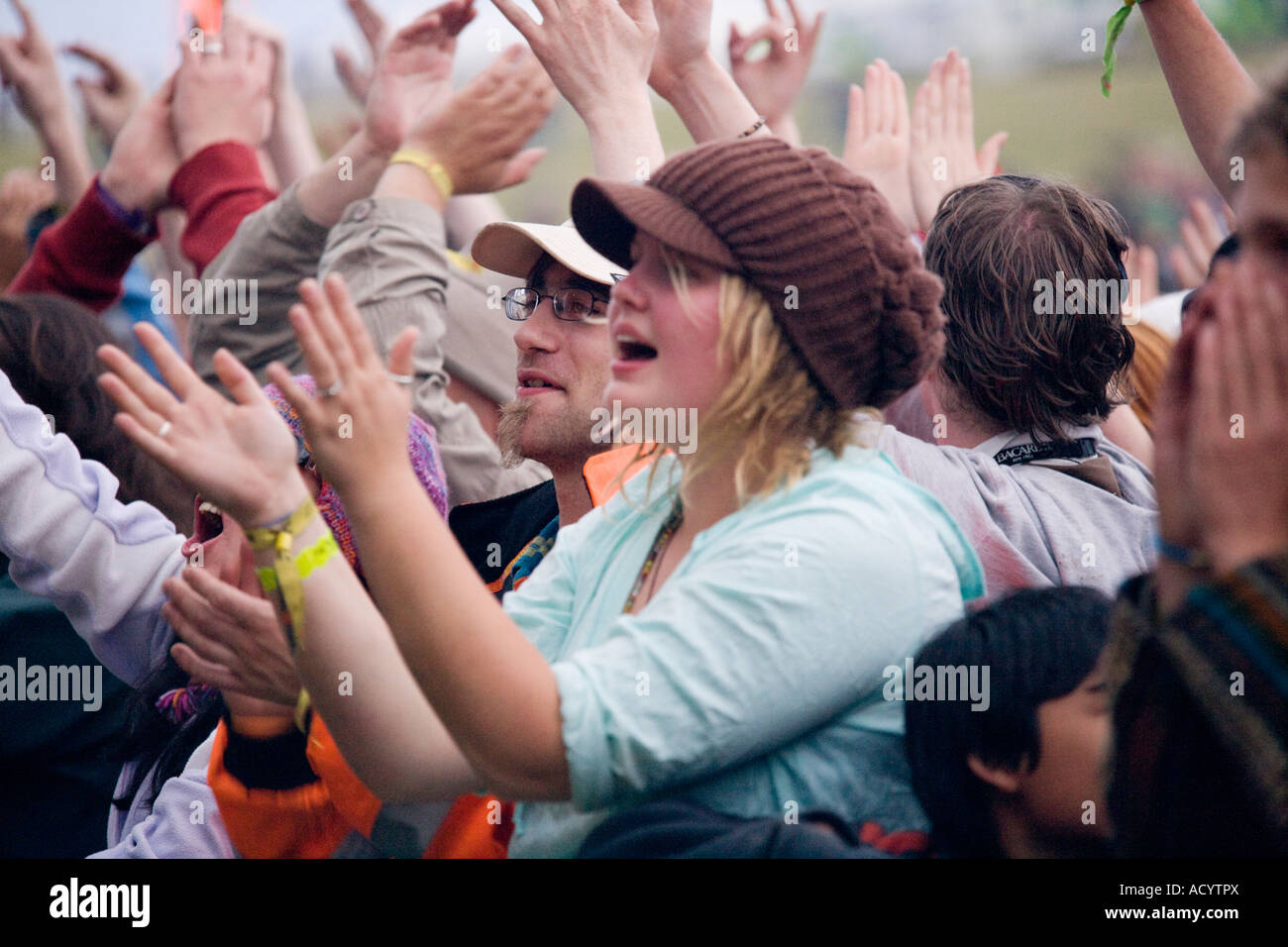 Photographs of the music fans at front of stage clapping at the ...