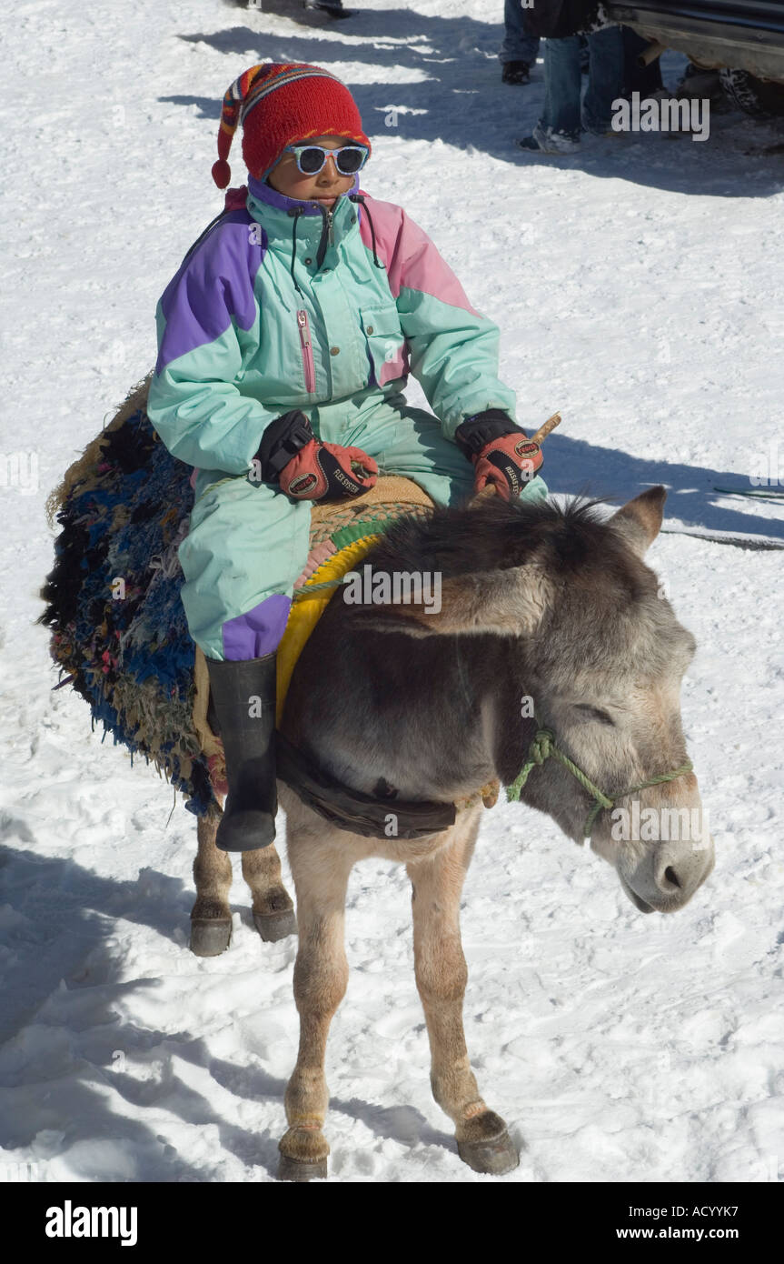 child on donkey snow on mountains Oukaimeden ski resort High Atlas ...