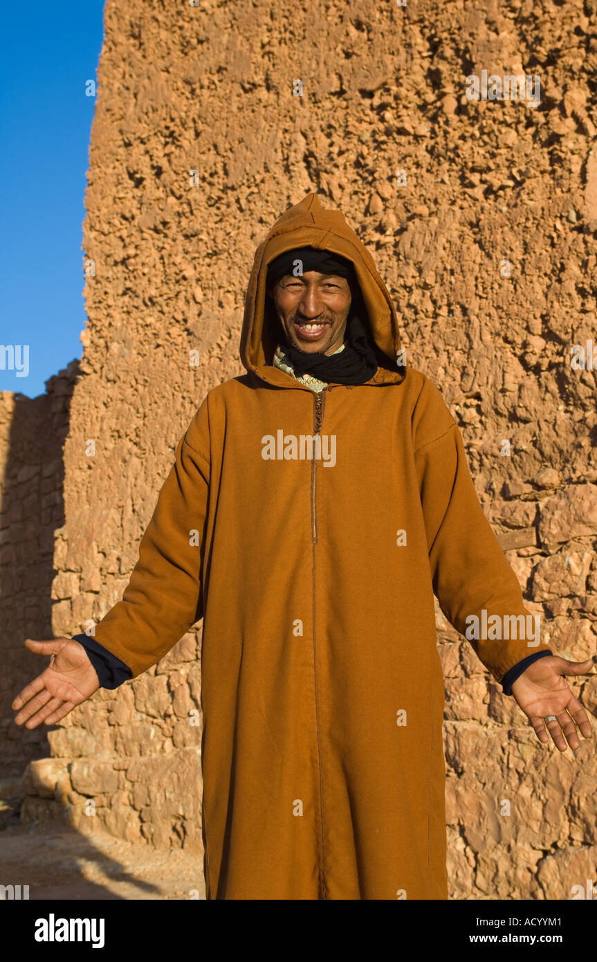 man in traditional berber clothes making tea on carpet Tinerhir oasis ...