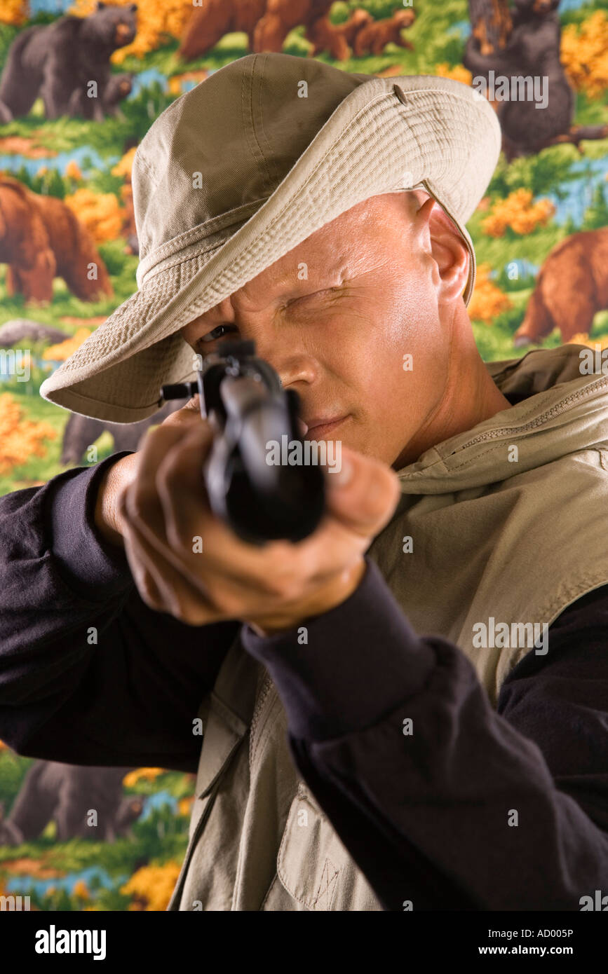 Mid adult Caucasian male pointing a rifle at viewer Stock Photo - Alamy