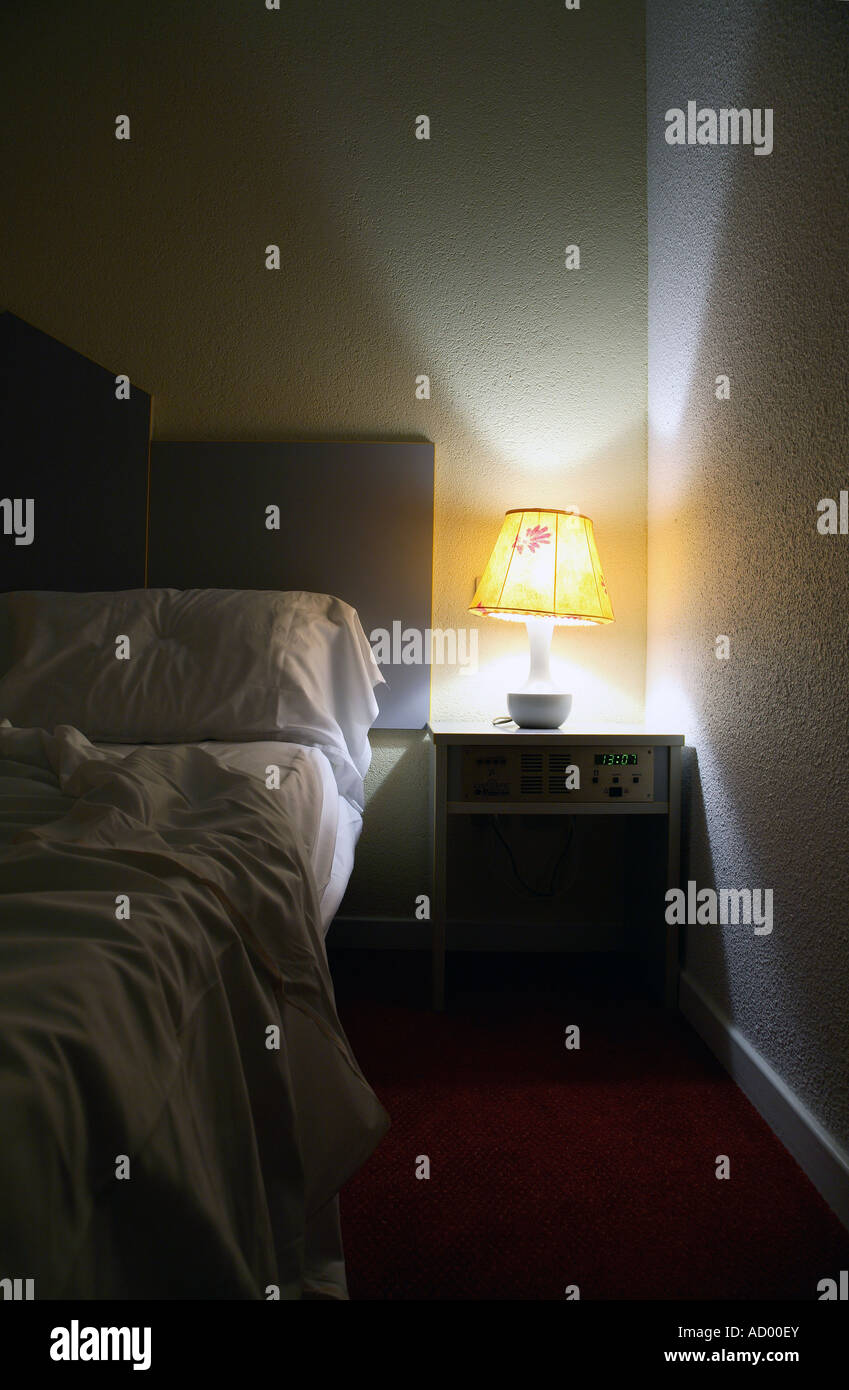 empty motel room with bed and lamp at night Stock Photo - Alamy