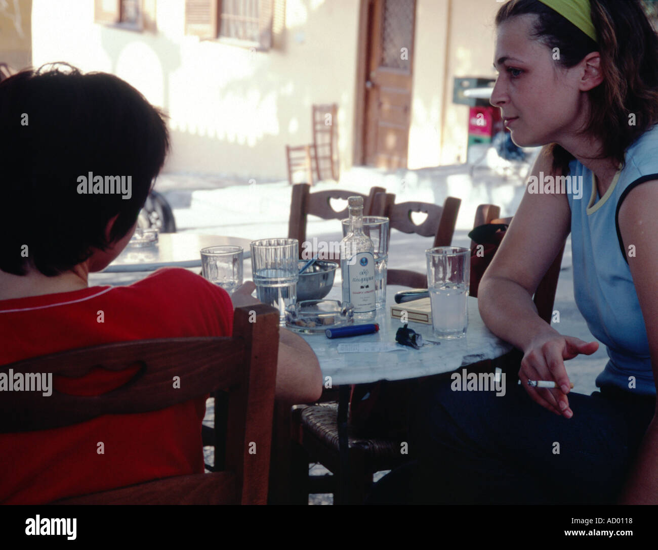 Two girls drinking the traditional Ouzo in bar at Plaka district Greece ...