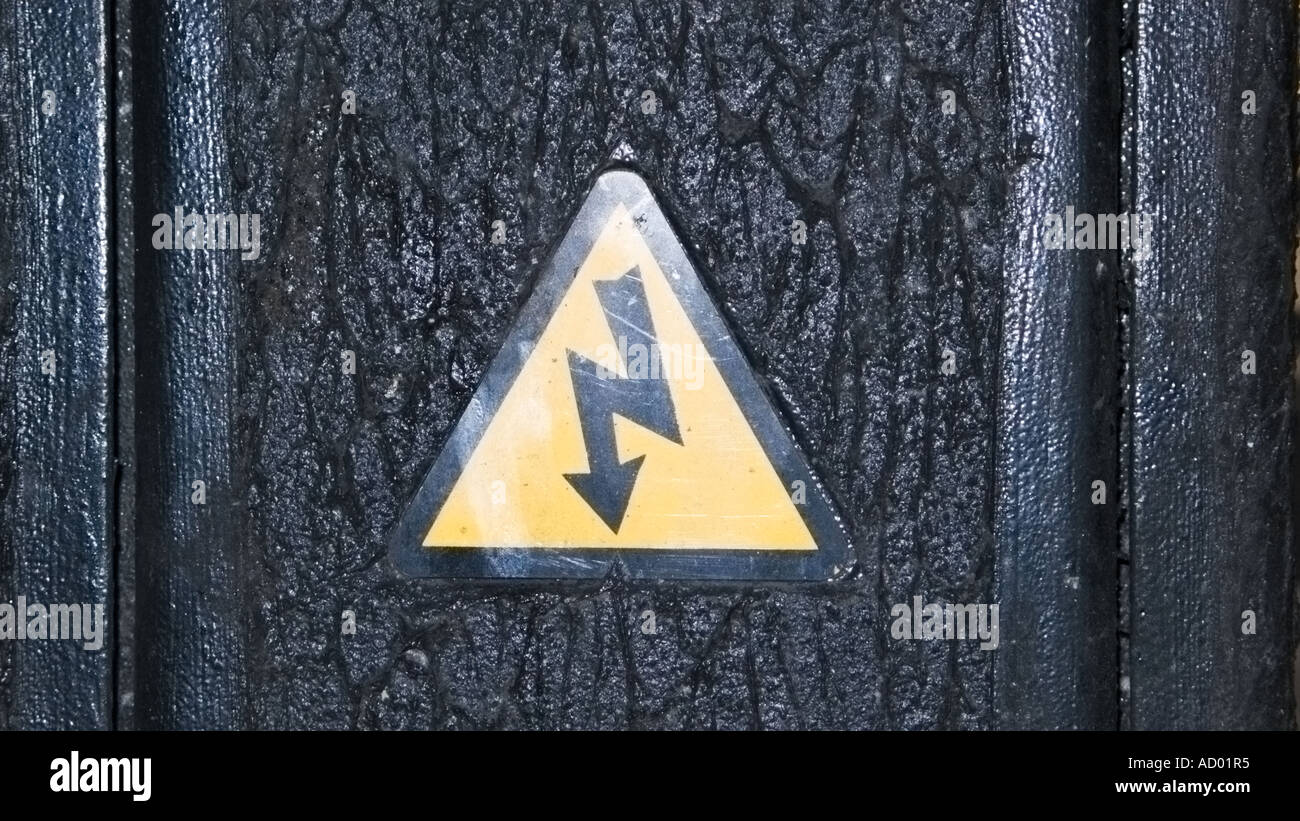Triangular yellow danger sign on door Stock Photo - Alamy