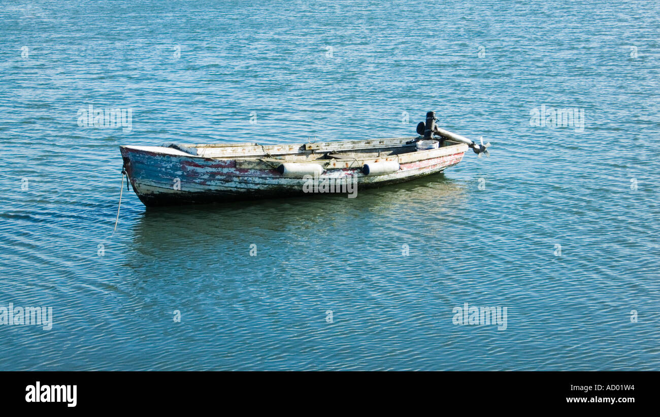 small wooden boat with engine floating on the water in Malahide ...