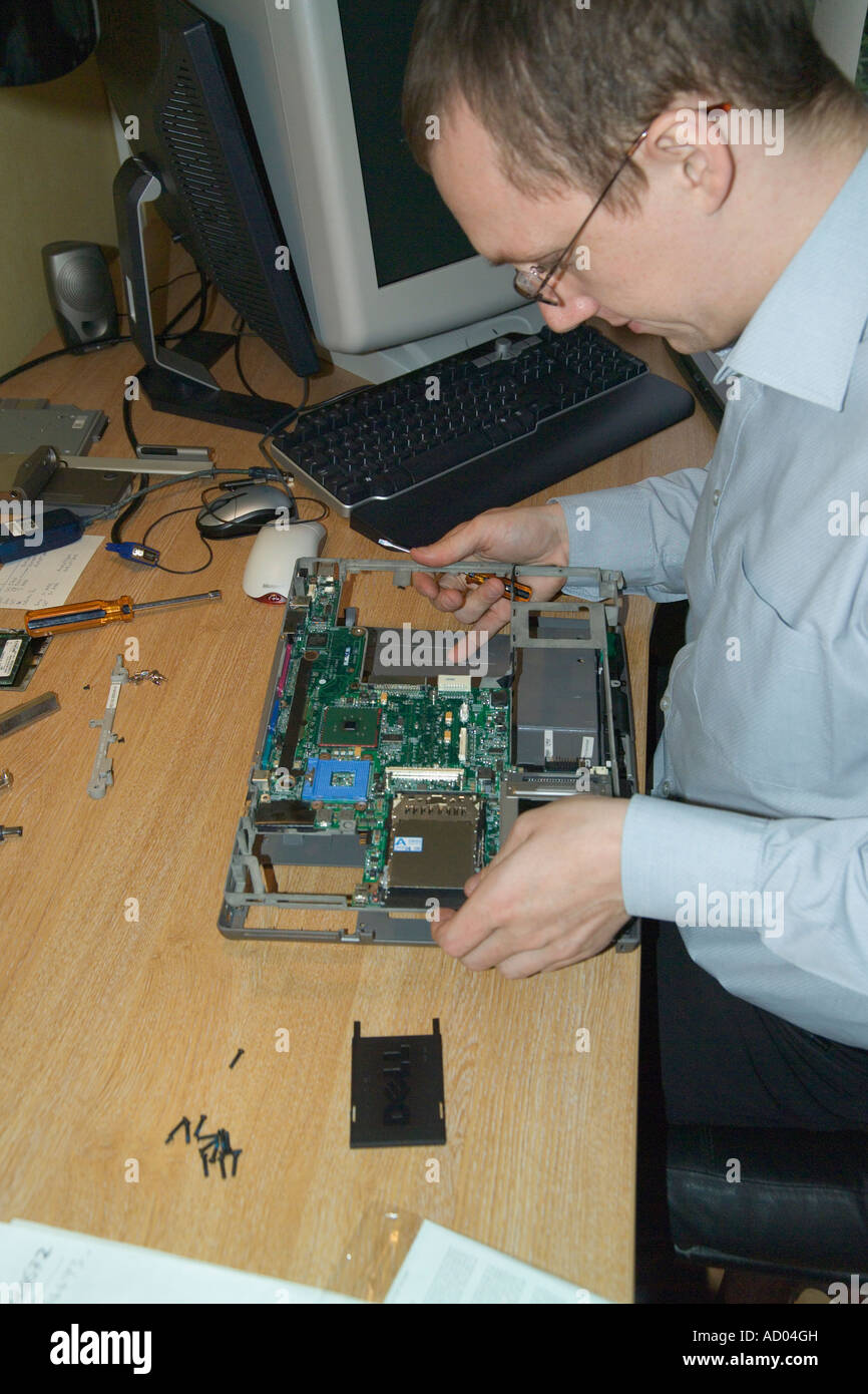 Engineer repairing a laptop computer changing motherboard Stock Photo ...