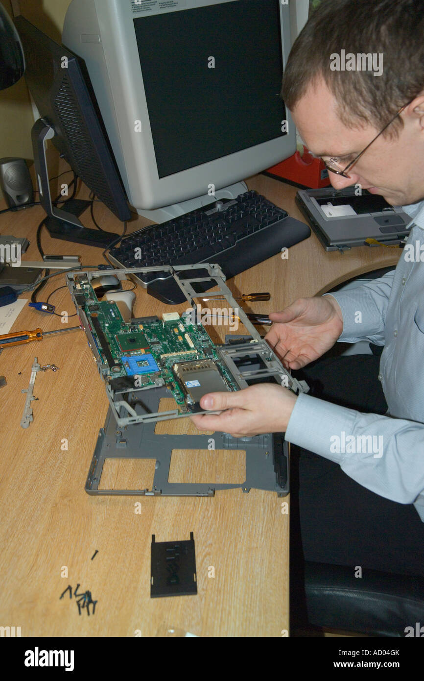 Engineer repairing a laptop computer changing motherboard Stock Photo ...
