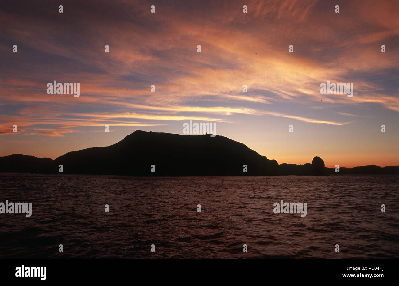 Viluchinsky volcano in colorful sunset ocean sky in crimson purple ...