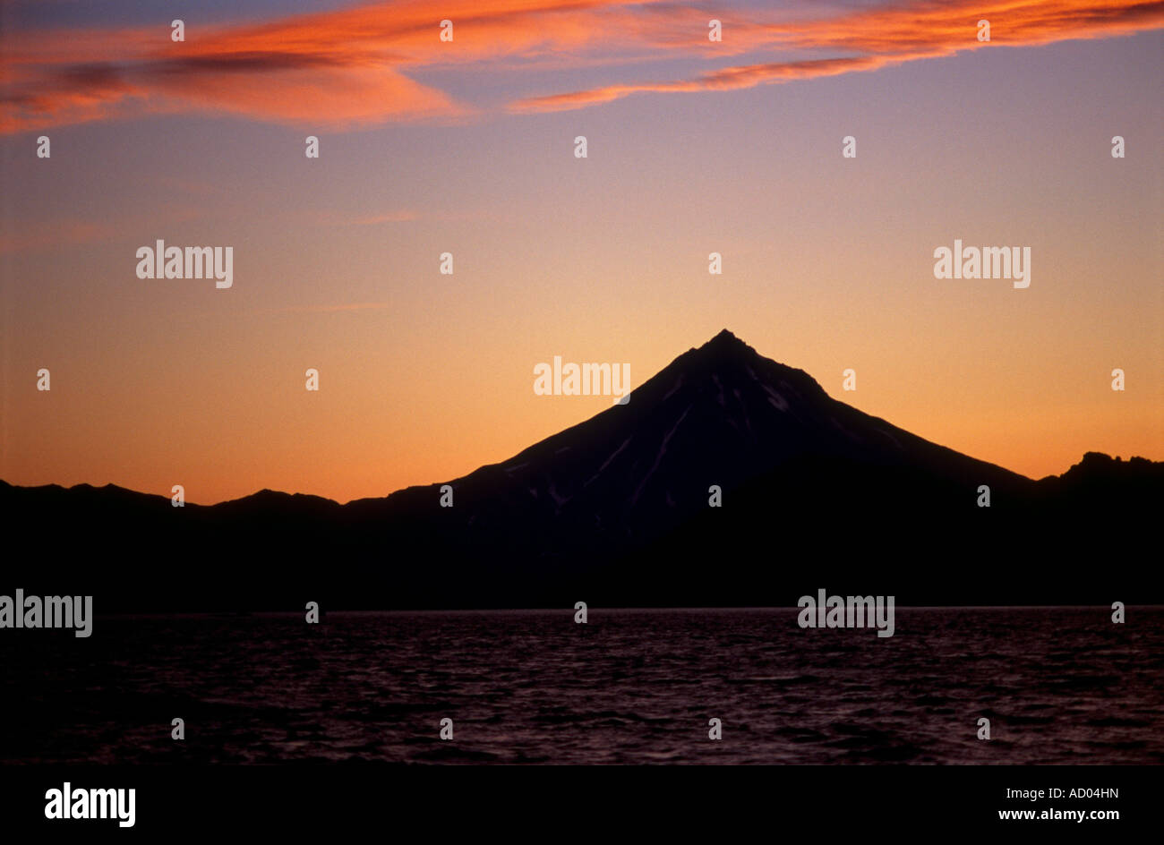 Viluchinsky volcano in colorful sunset ocean sky in crimson purple ...