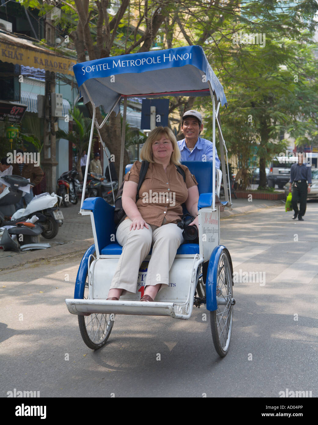 Rickshaw tourist riding through hanoi hi-res stock photography and ...