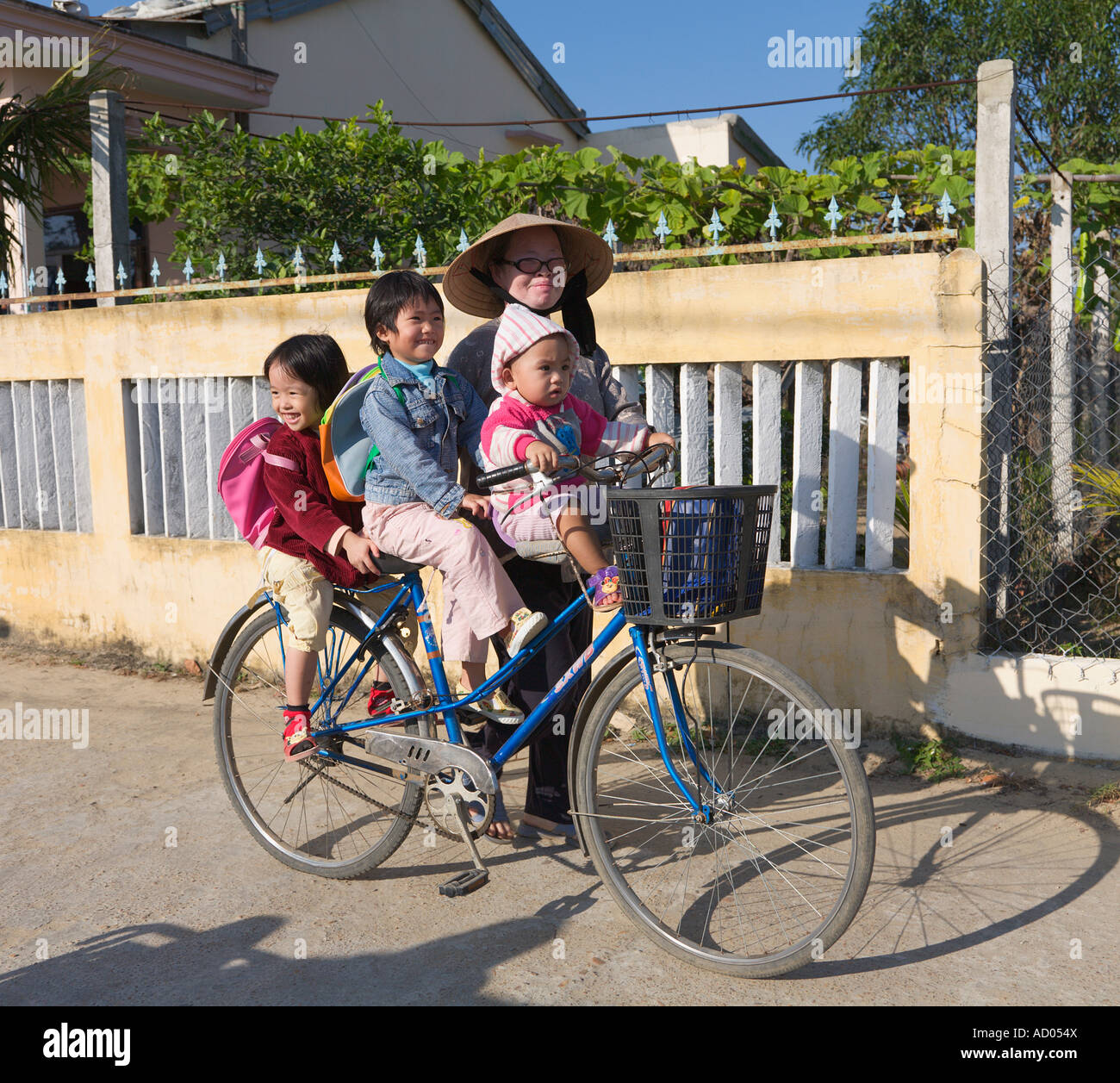 Young children on a bicycle coming home from school "Hoi An" Vietnam ...